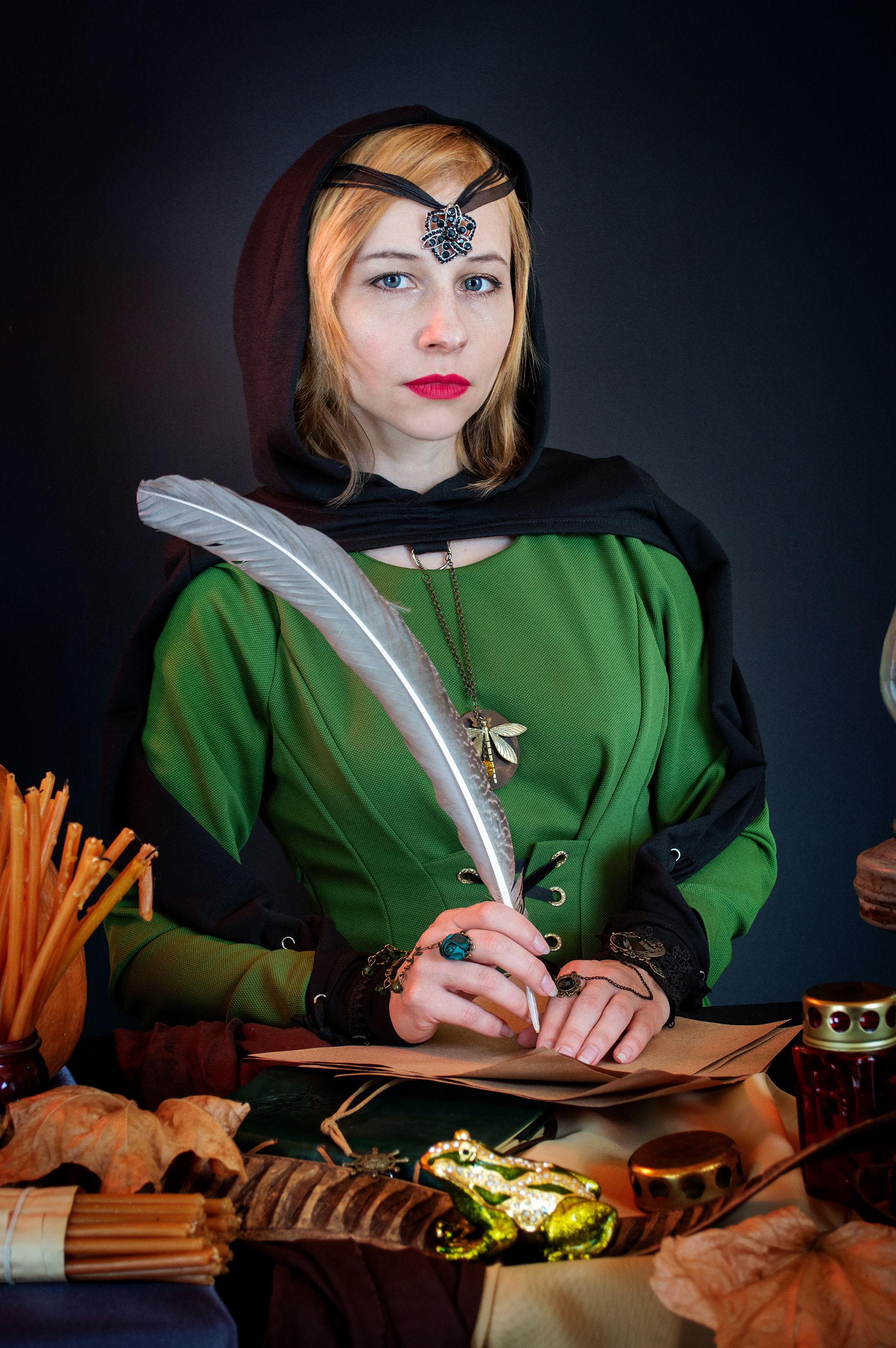 Crop soothsayer with talisman and tarot cards near glowing candle ...