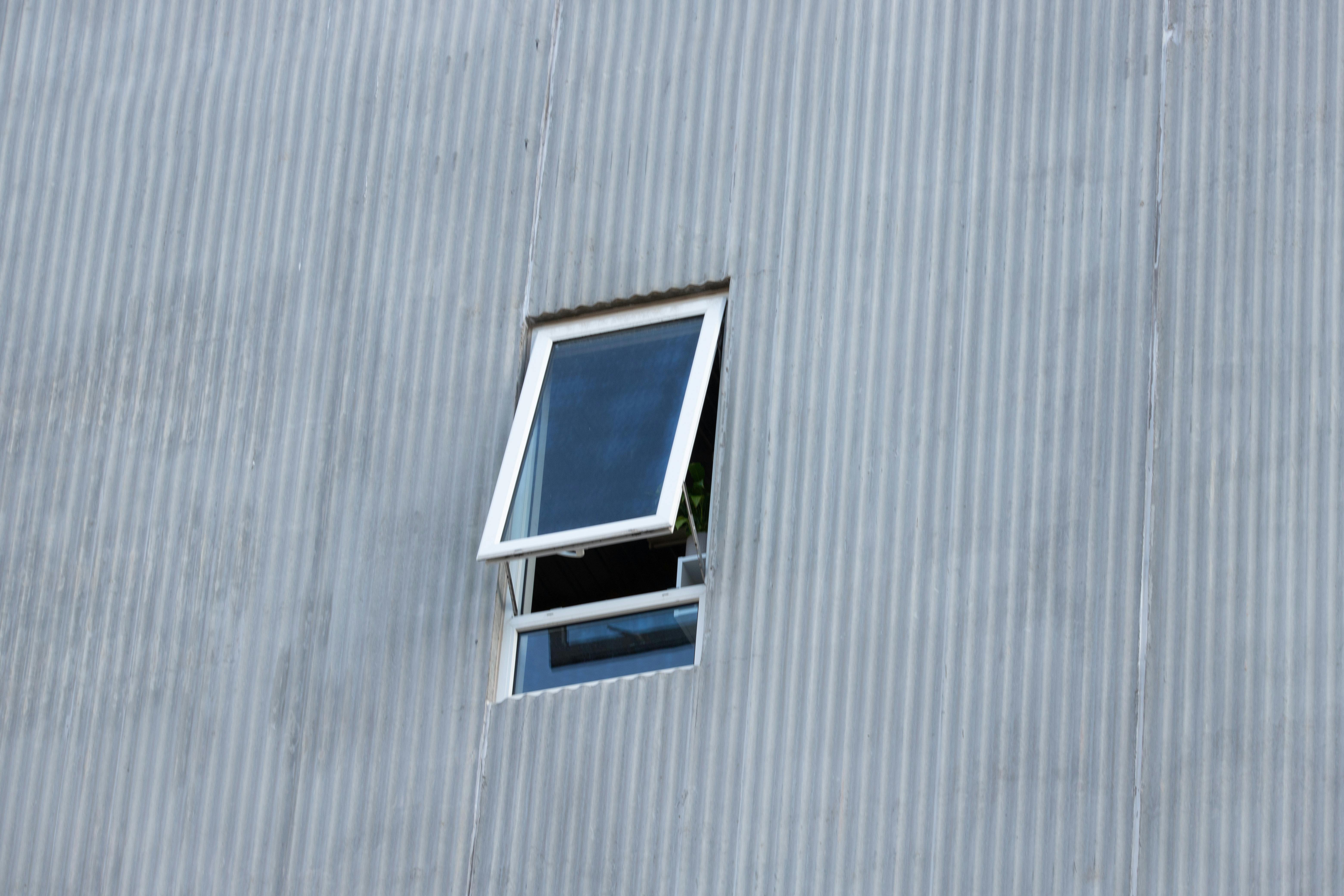 Photograph of a Building with an Open Window · Free Stock Photo