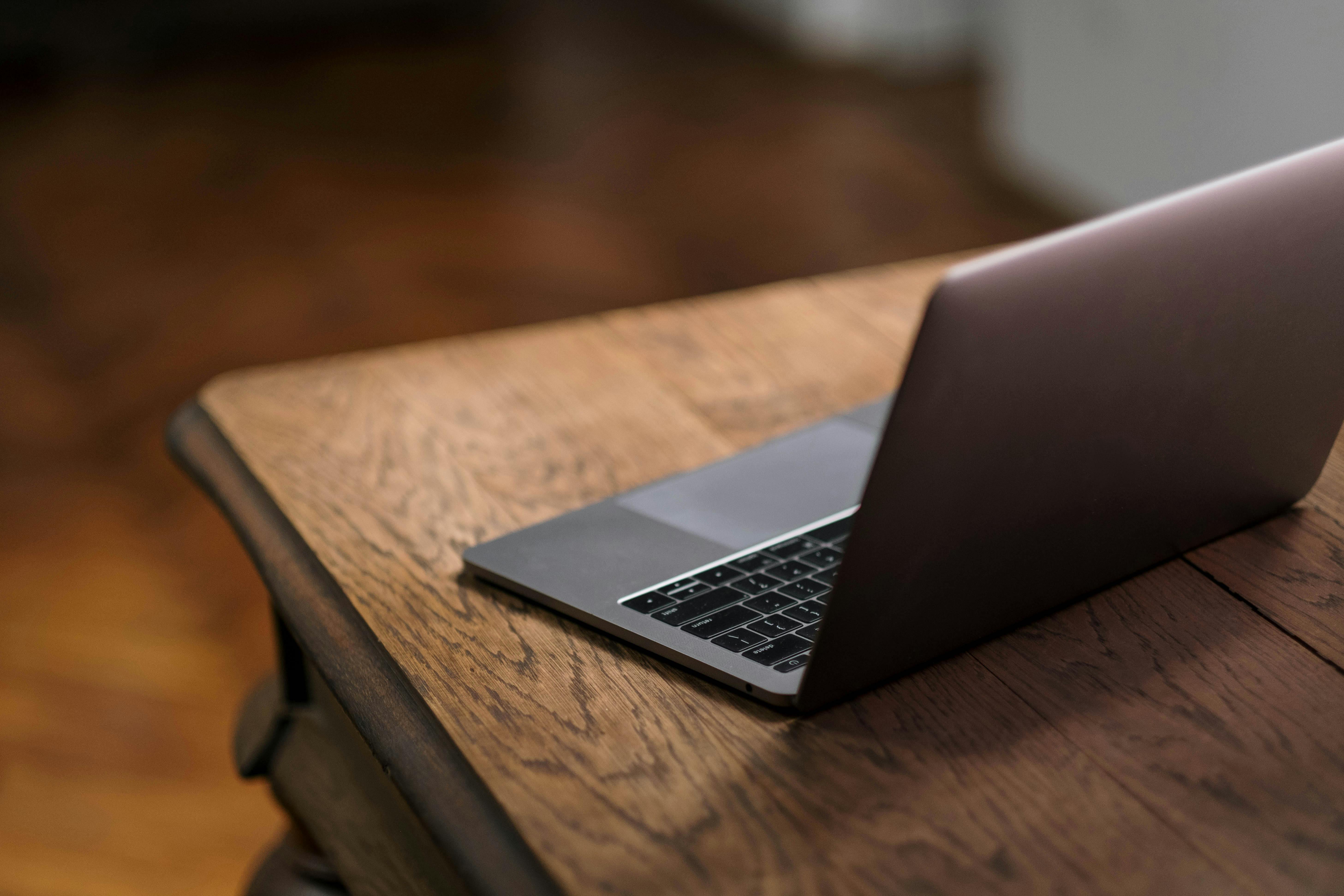 Close-up Photo of Laptop on White Surface · Free Stock Photo