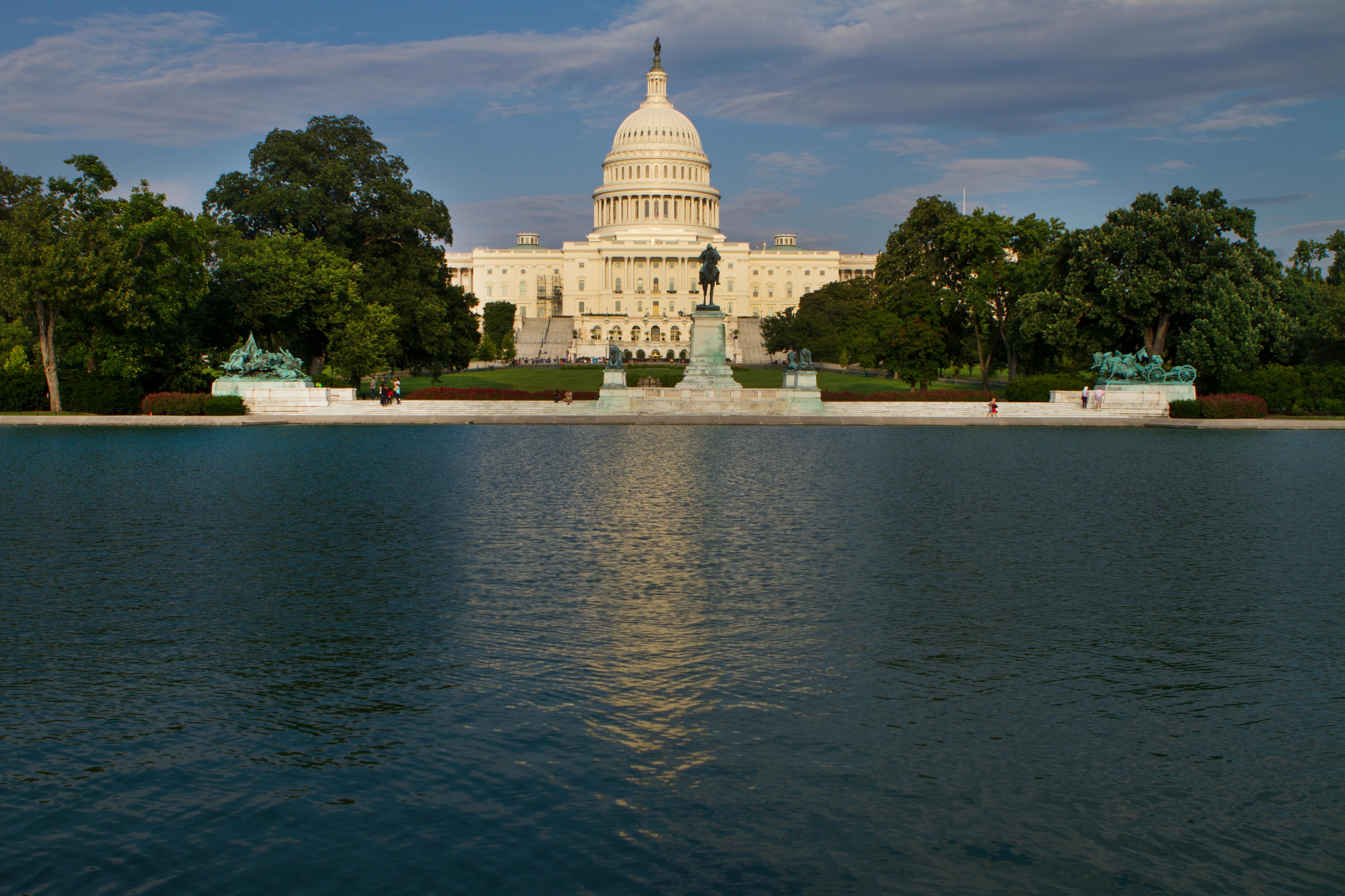 White Dome Building Near Green Trees and Body of Water · Free Stock Photo