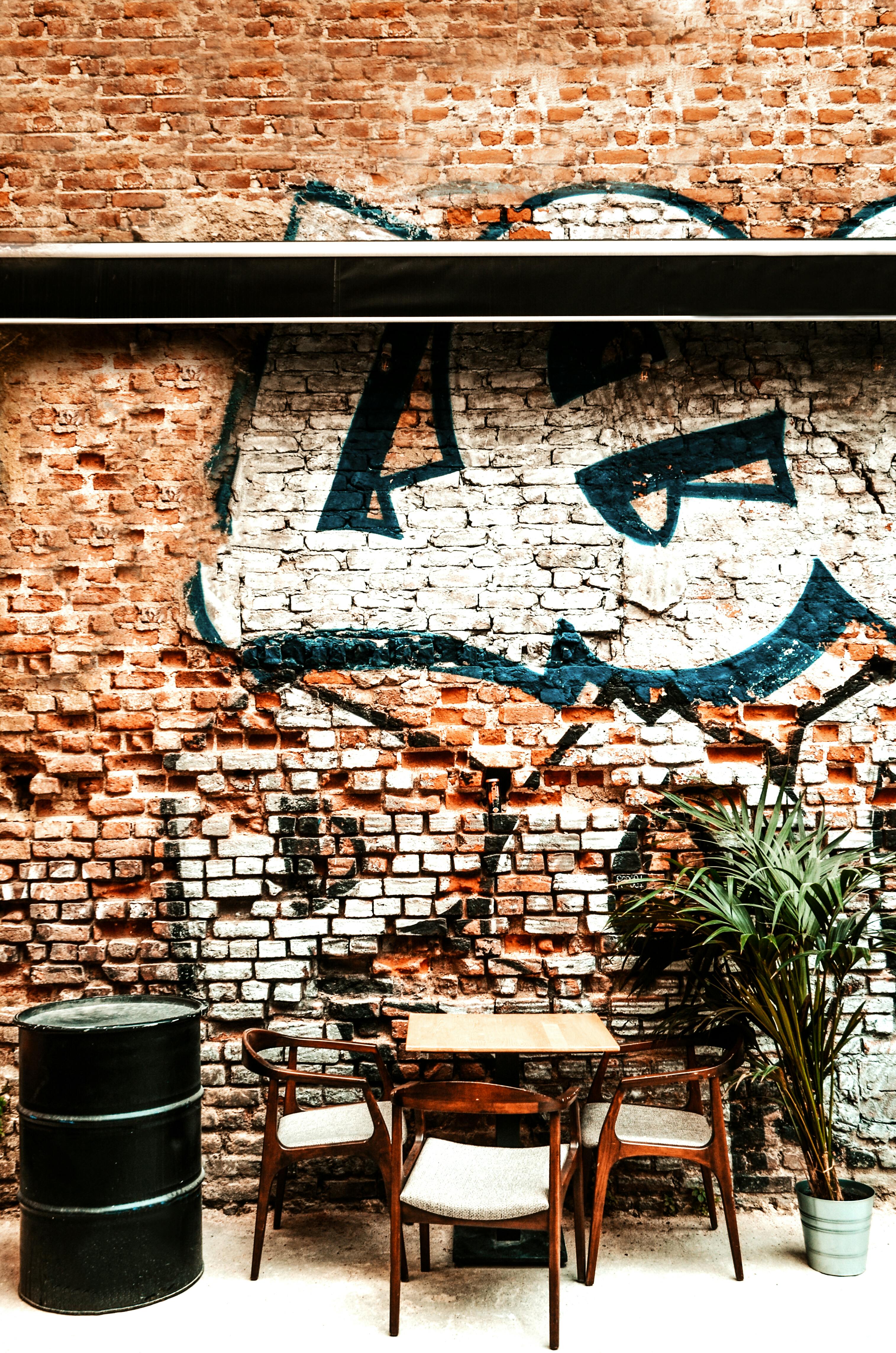 Street cafe near old graffiti wall in city · Free Stock Photo
