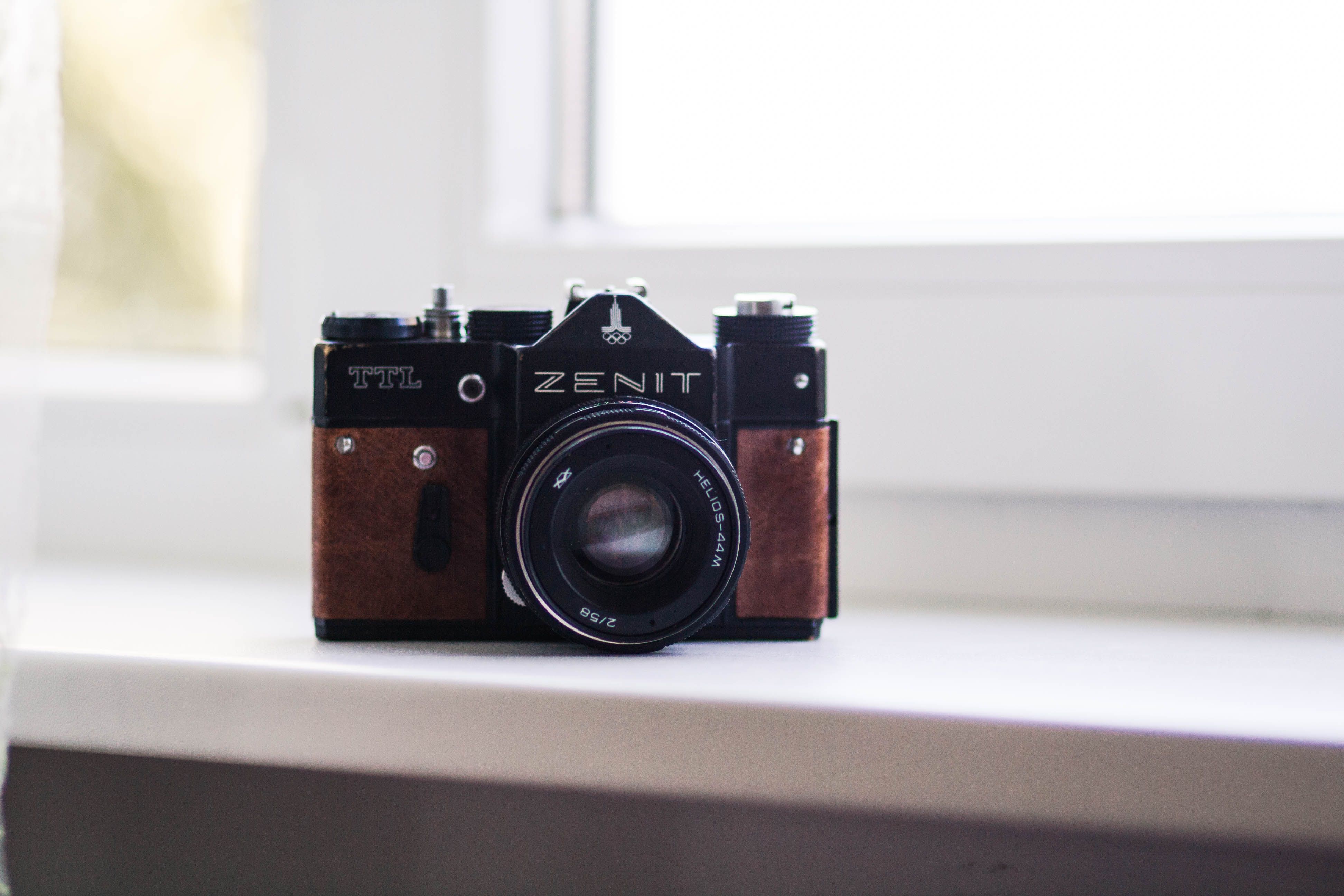 Retro photo camera on windowsill indoors · Free Stock Photo
