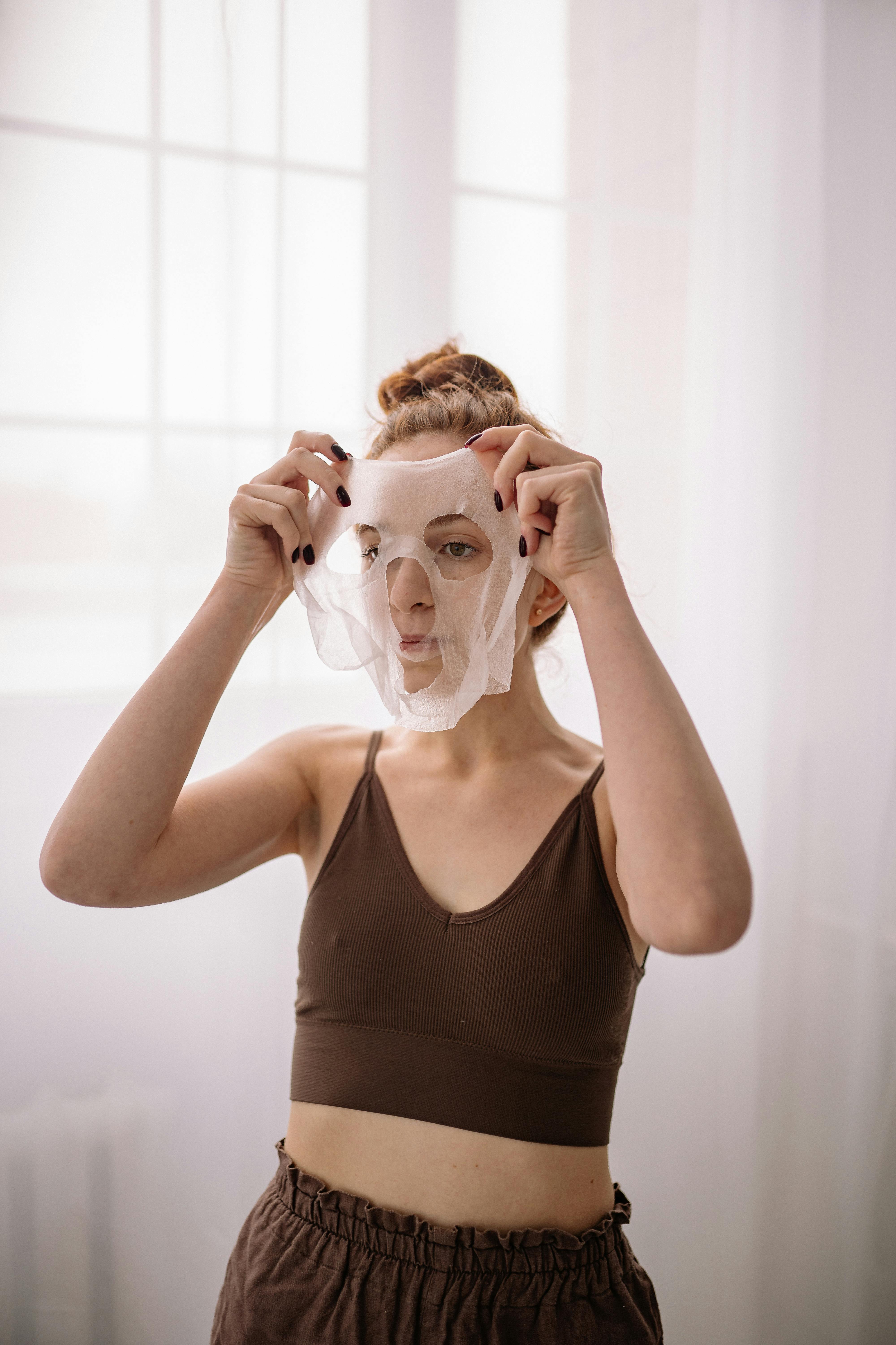 Woman applying a Face Mask · Free Stock Photo