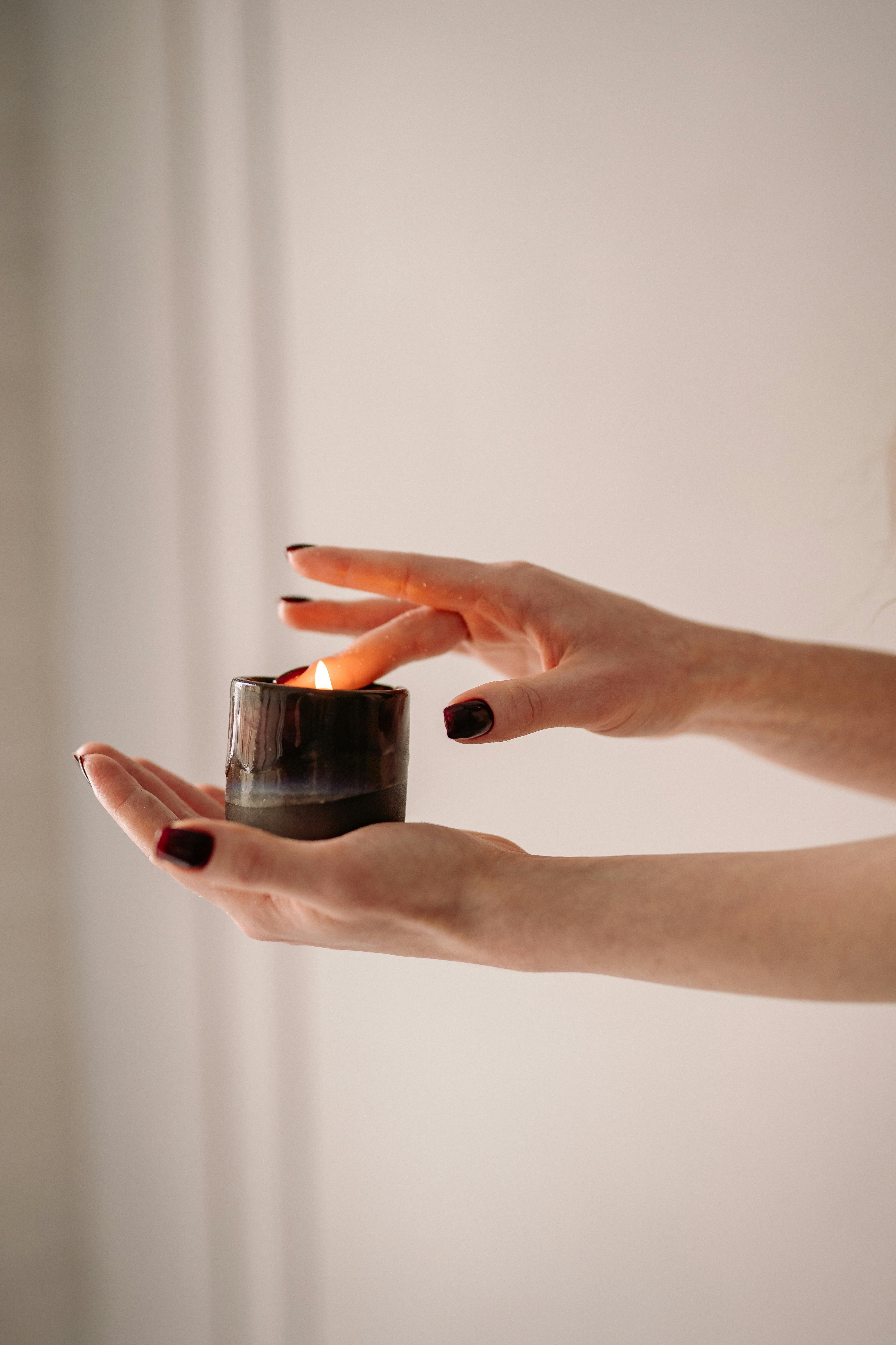 A Person Holding a Burning Candle · Free Stock Photo