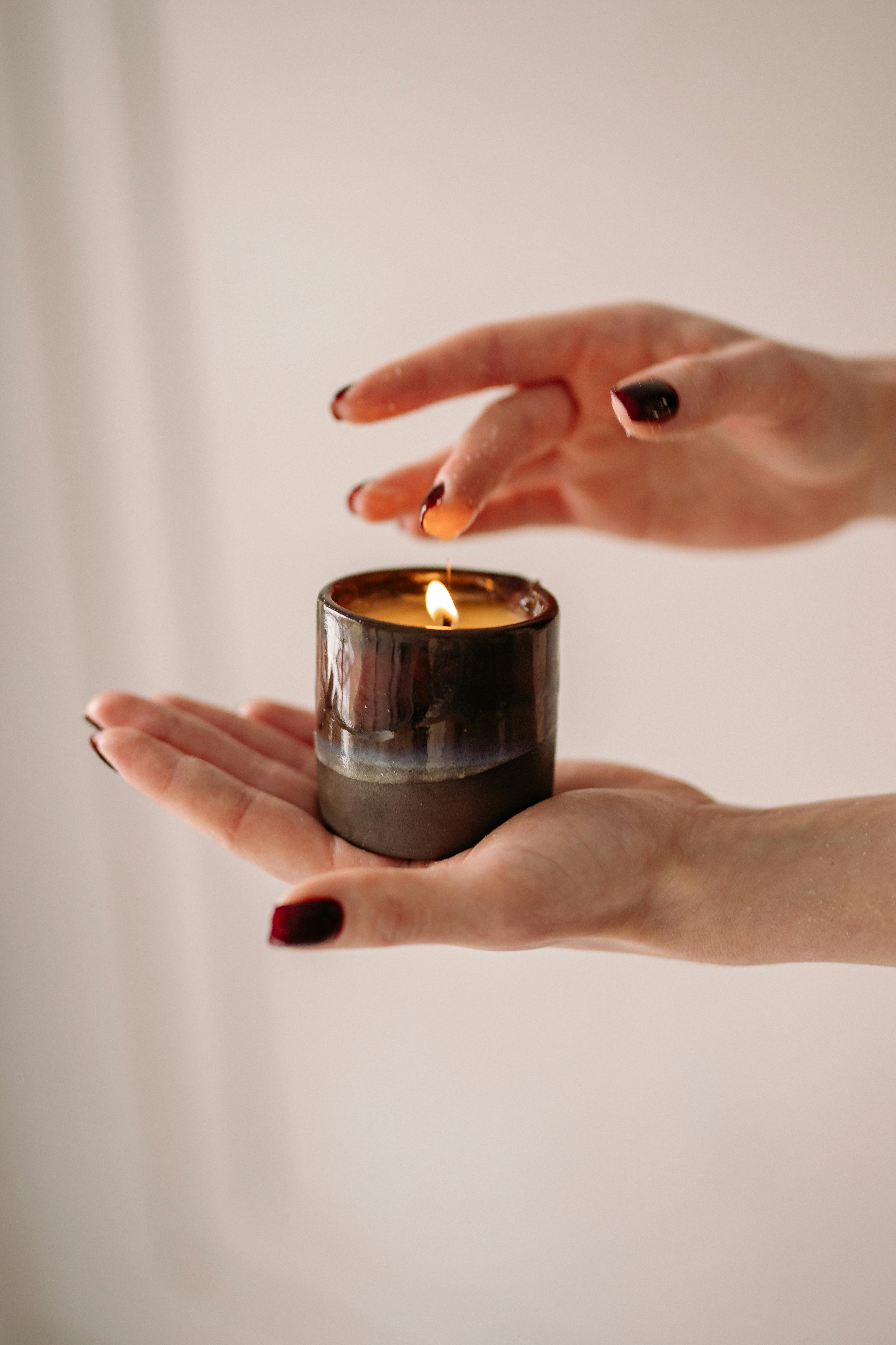A Lit Candle on a Hand · Free Stock Photo