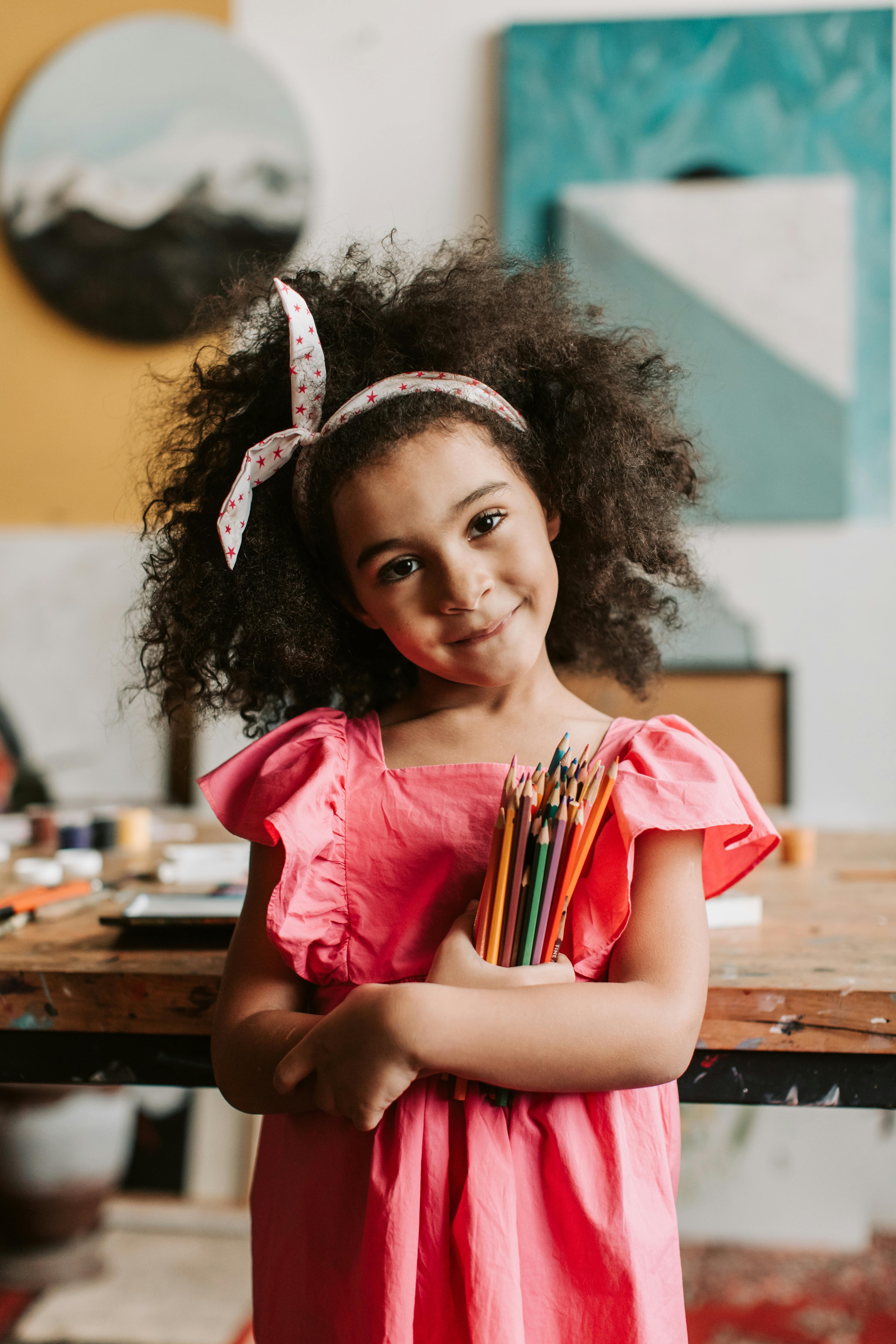Girl Holding Colored Pencils · Free Stock Photo