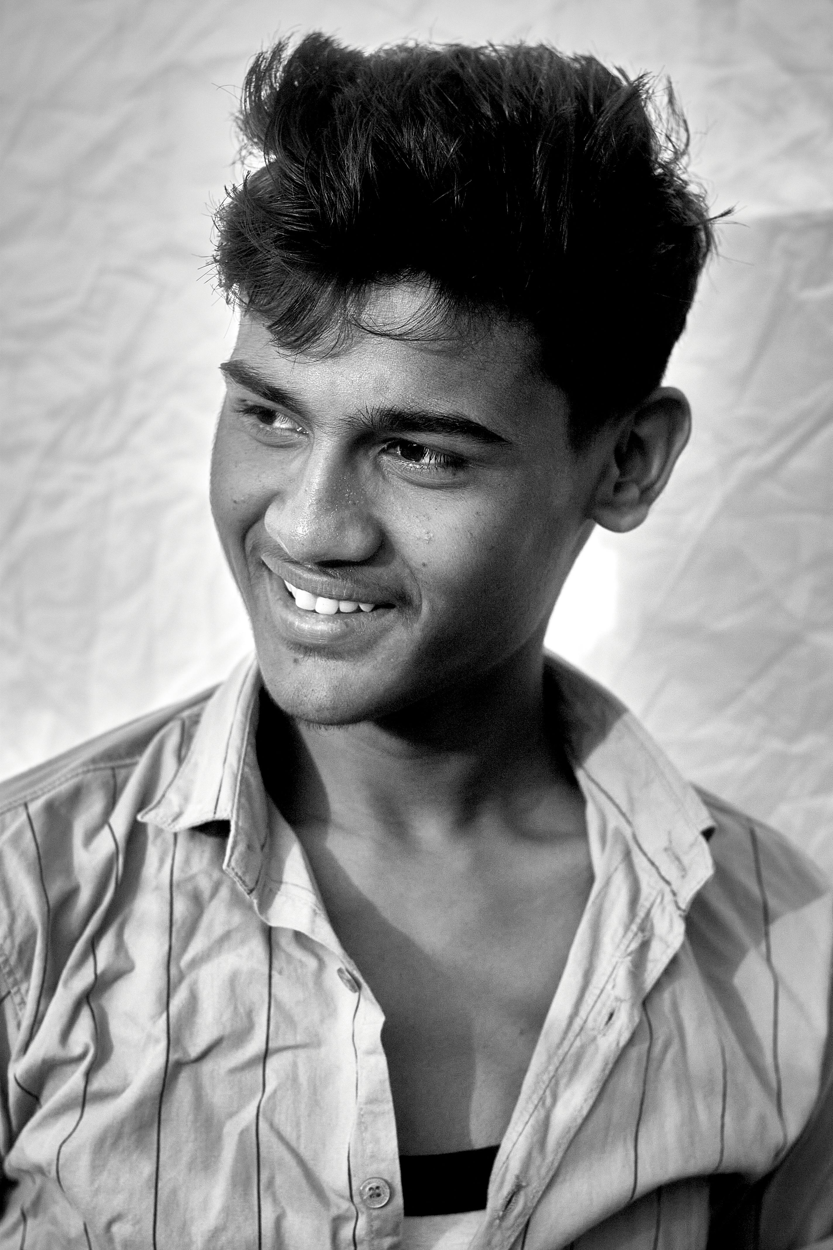 Grayscale Photo of a Man Holding Black DSLR Camera · Free Stock Photo