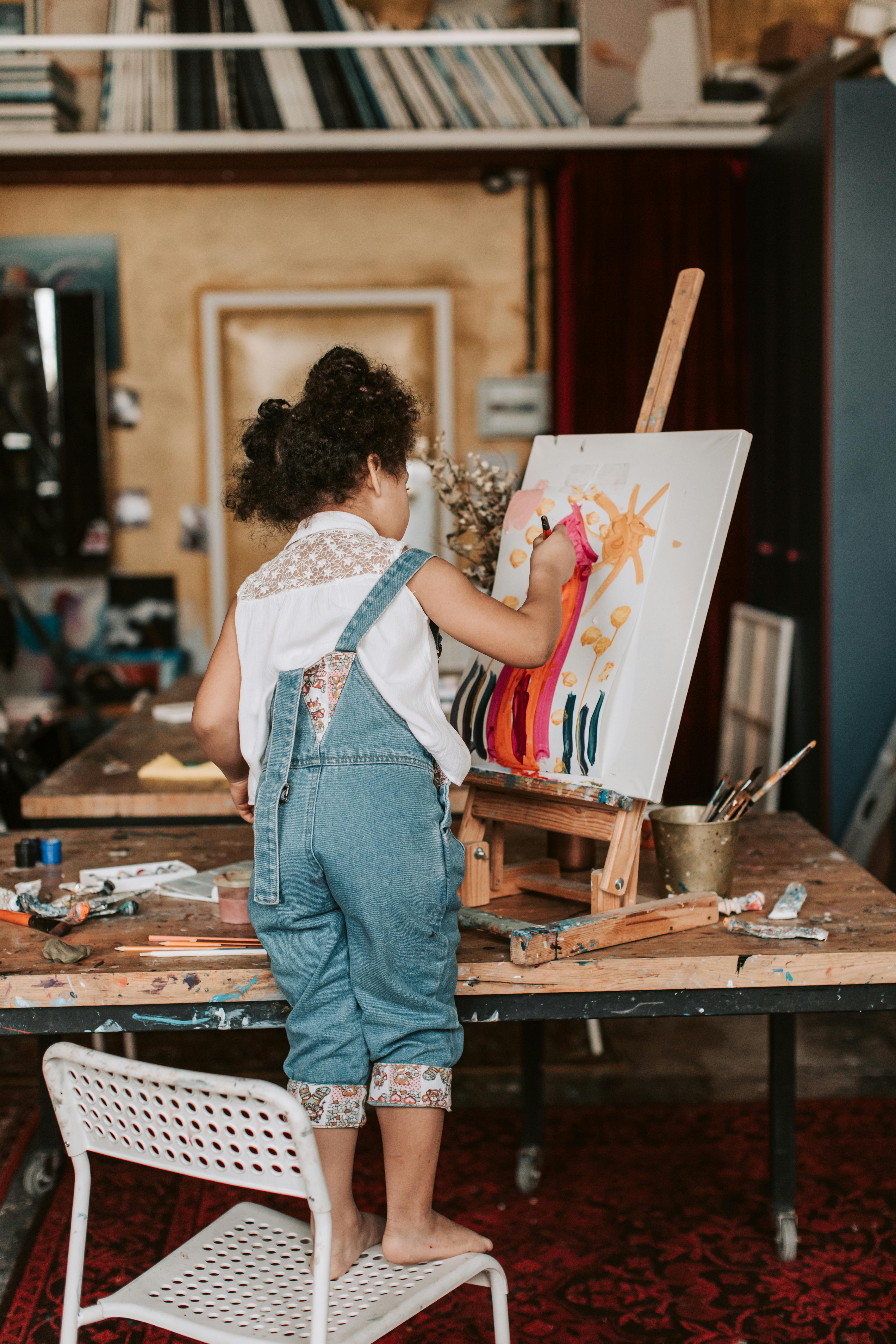 Back View of a Girl Painting · Free Stock Photo