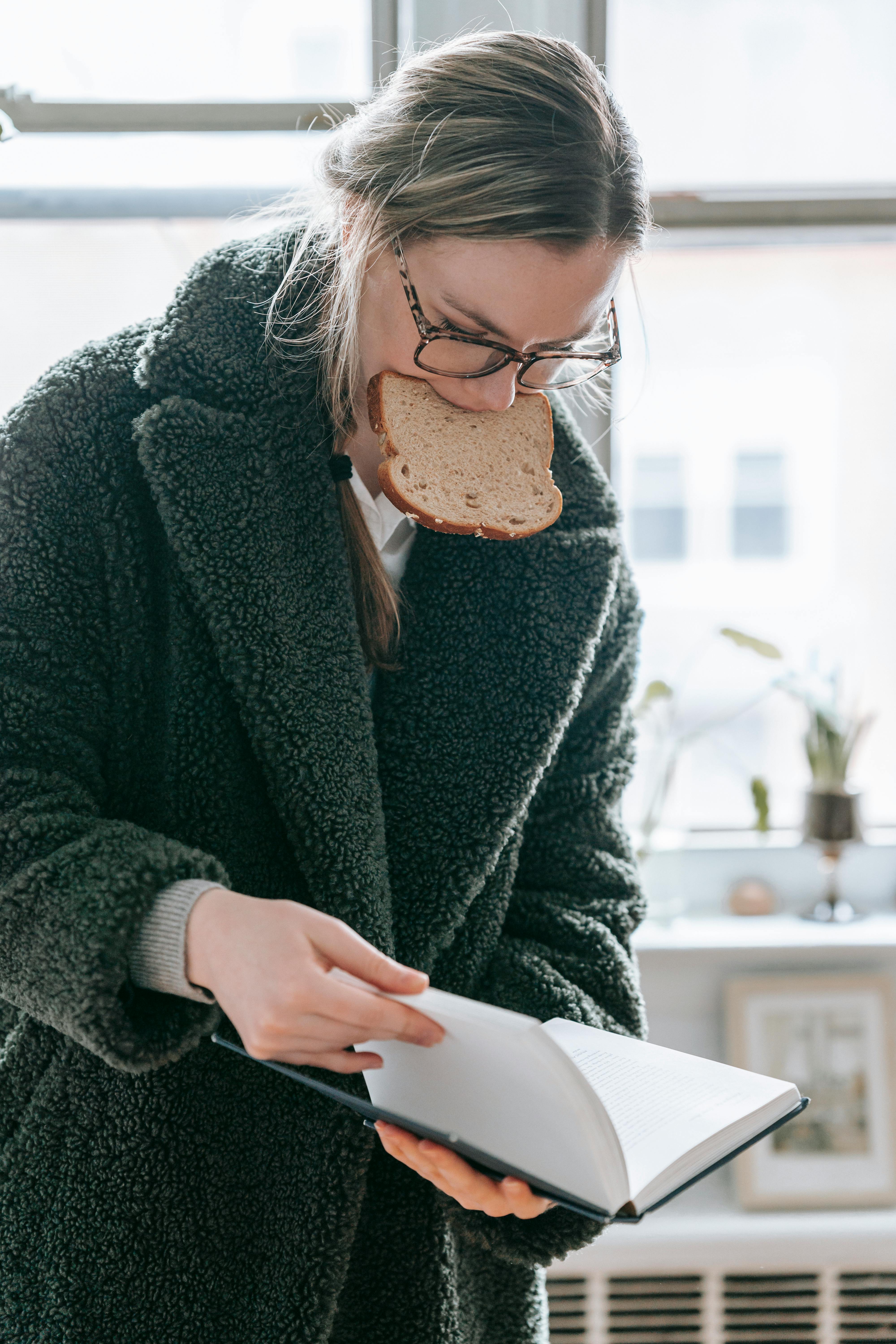 Woman with bread reading book · Free Stock Photo