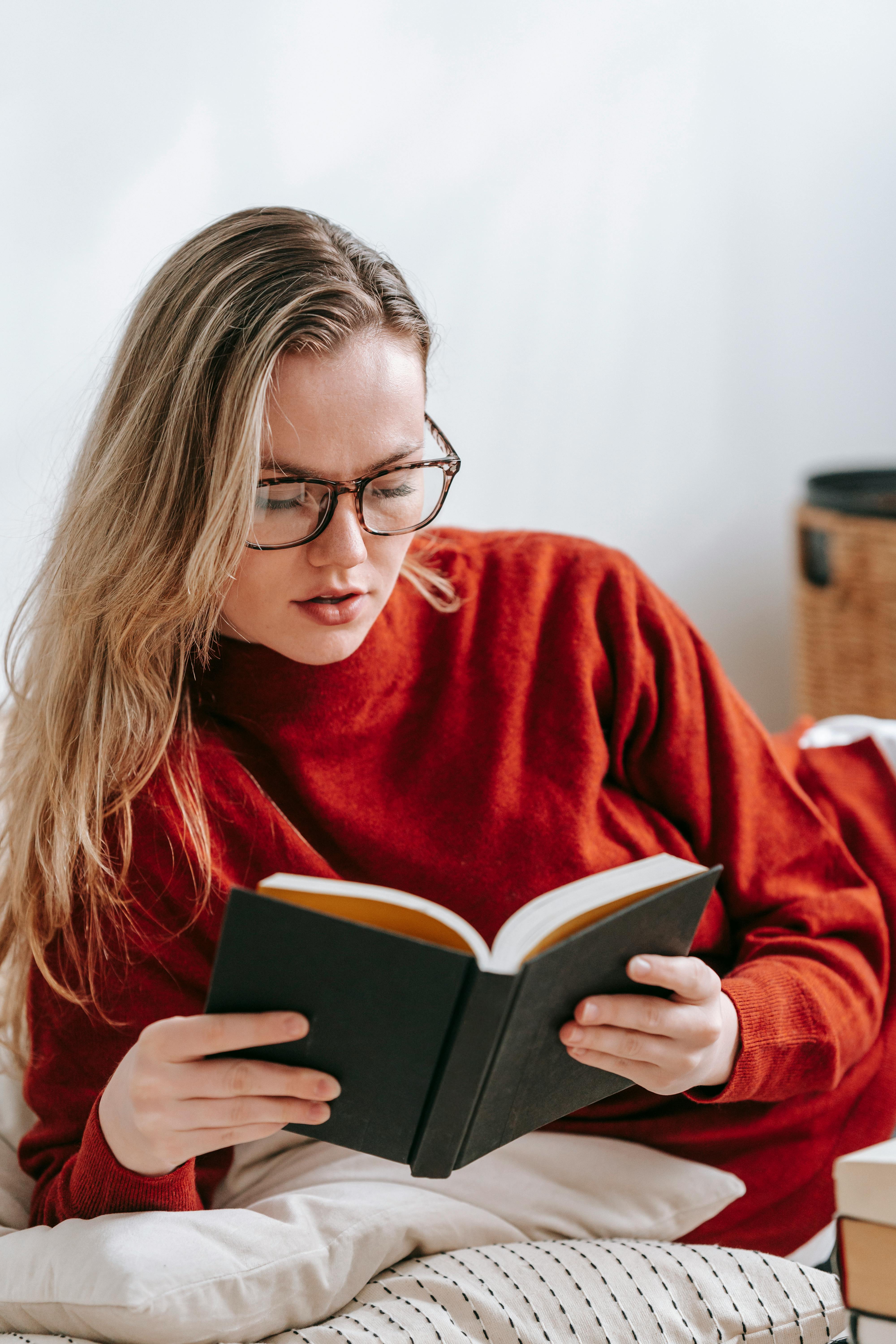 Thoughtful woman reading book · Free Stock Photo