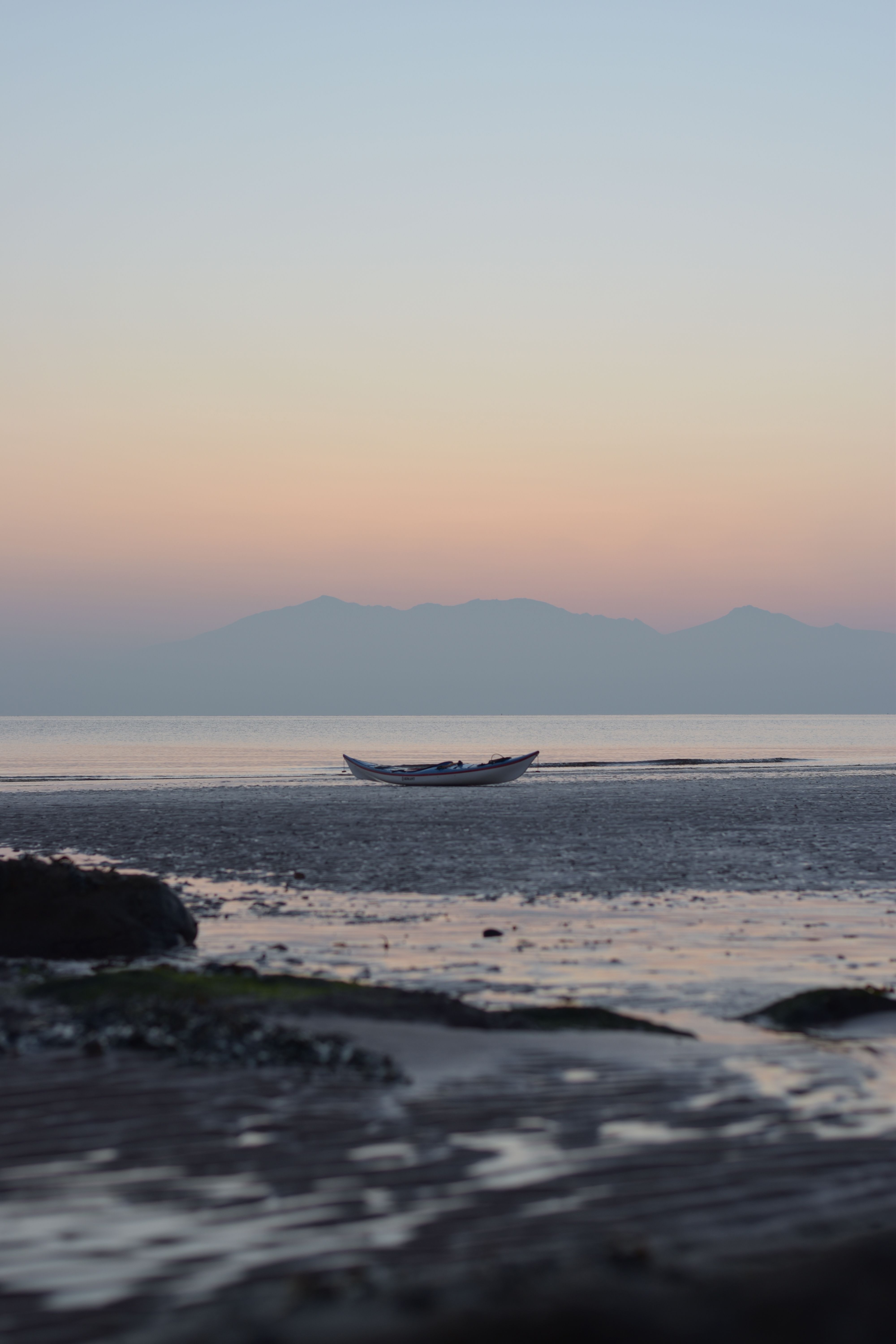 White and Red Boat on Seashore Under Gloomy Sky · Free Stock Photo