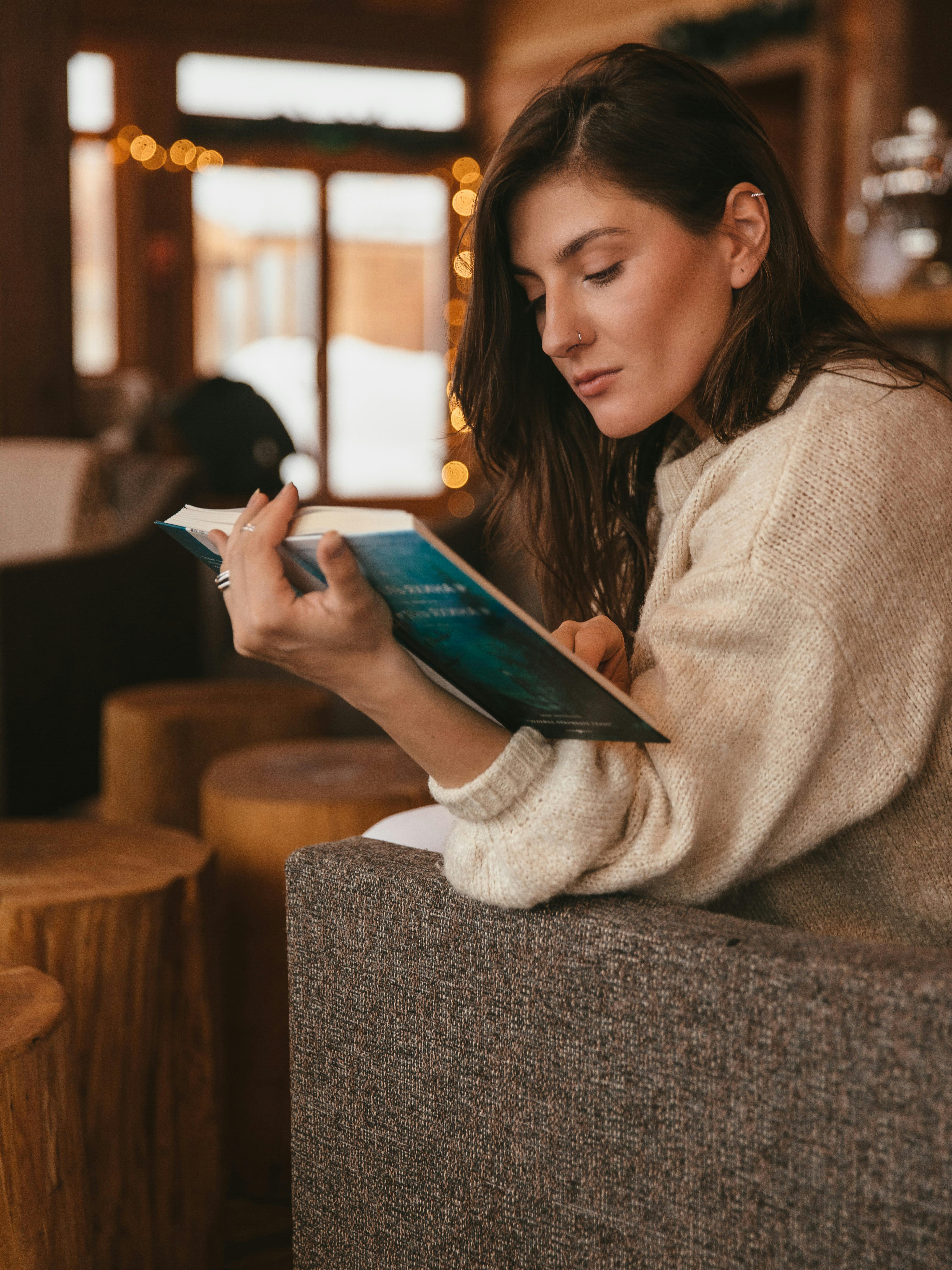 Side View of a Beautiful Woman Reading a Book · Free Stock Photo