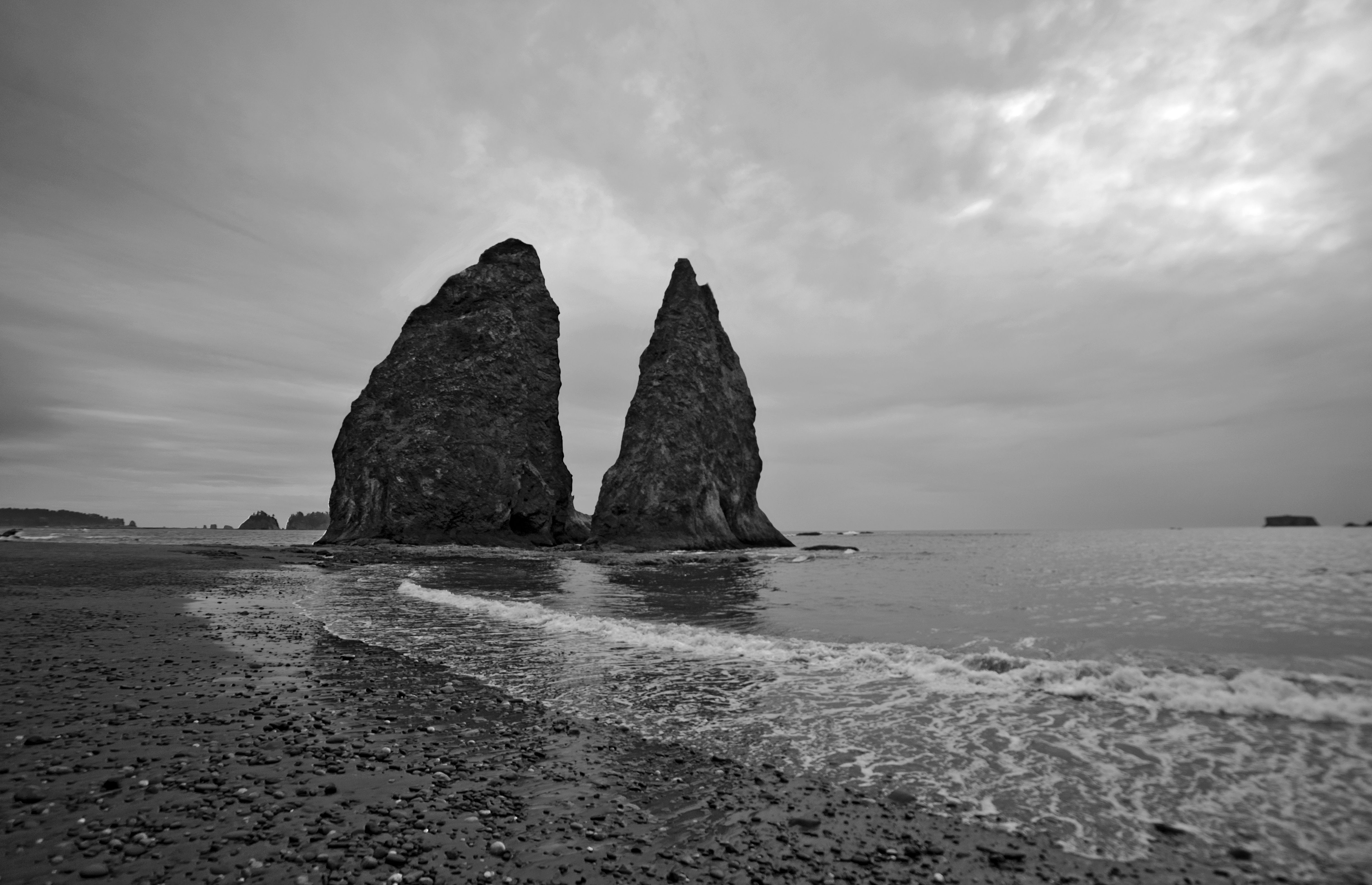 Grayscale Photo of Rock Formation on the Seashore · Free Stock Photo
