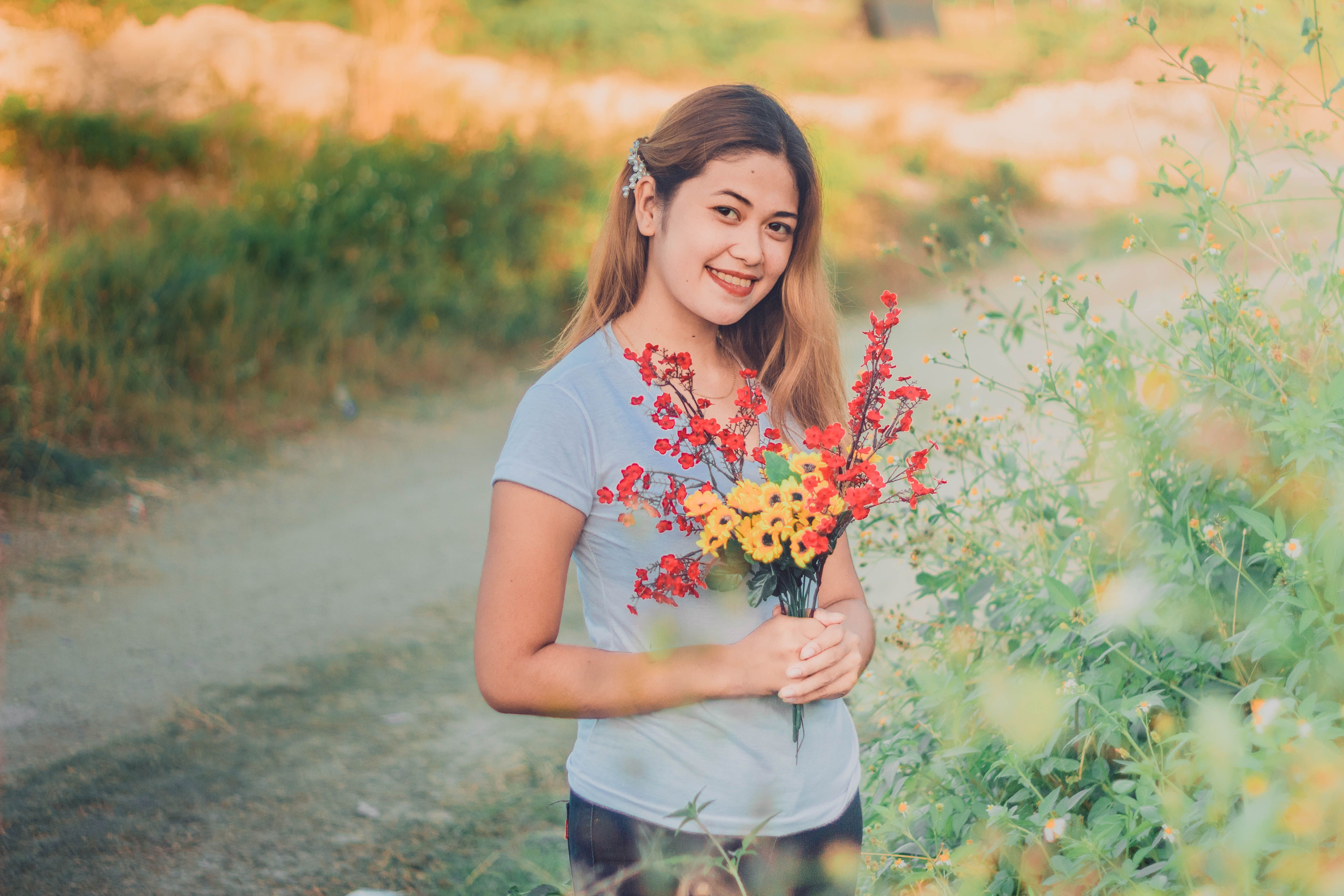 Smiling Gardener among Plants · Free Stock Photo