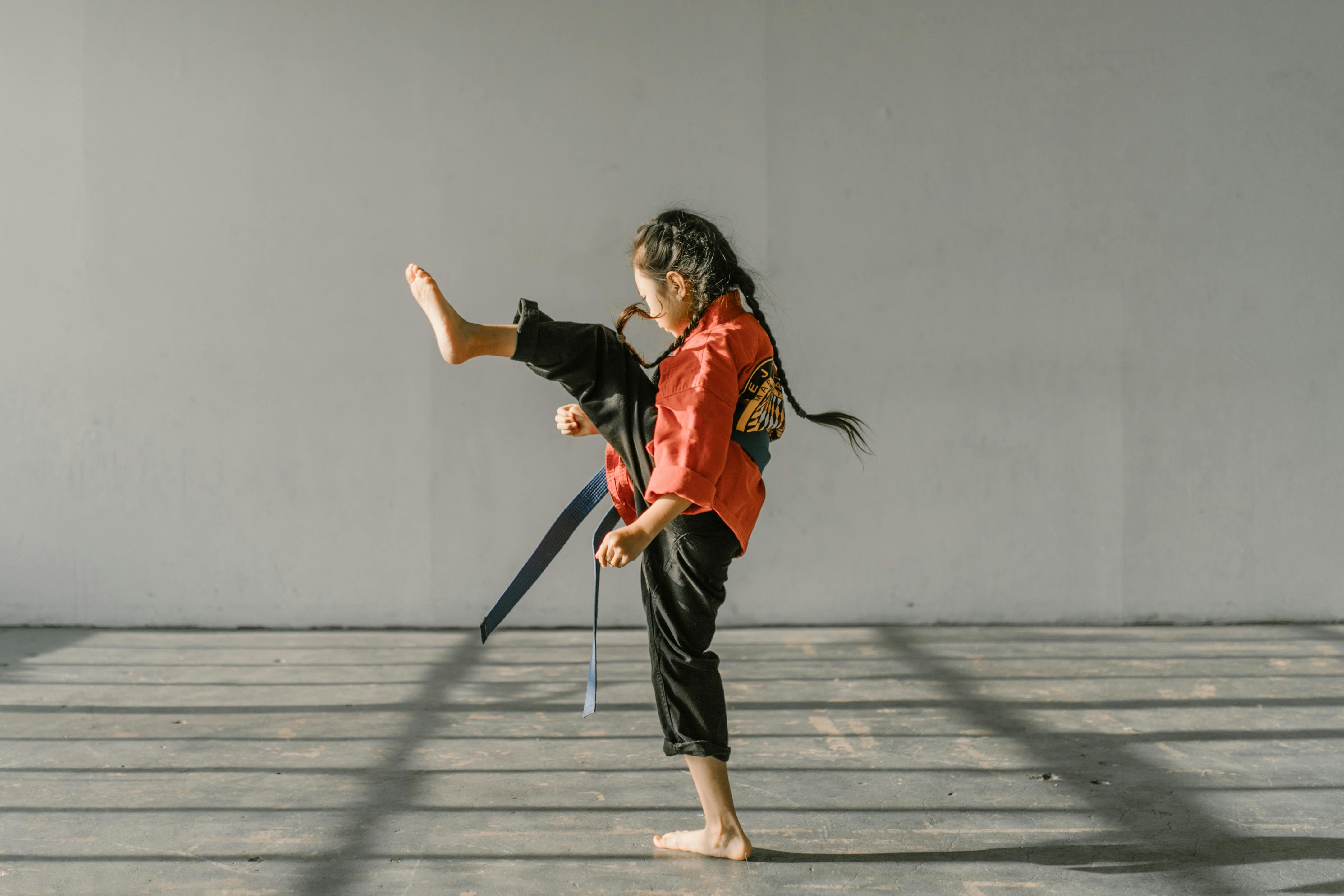 Man in Black Karate Uniform Holding a Stick · Free Stock Photo