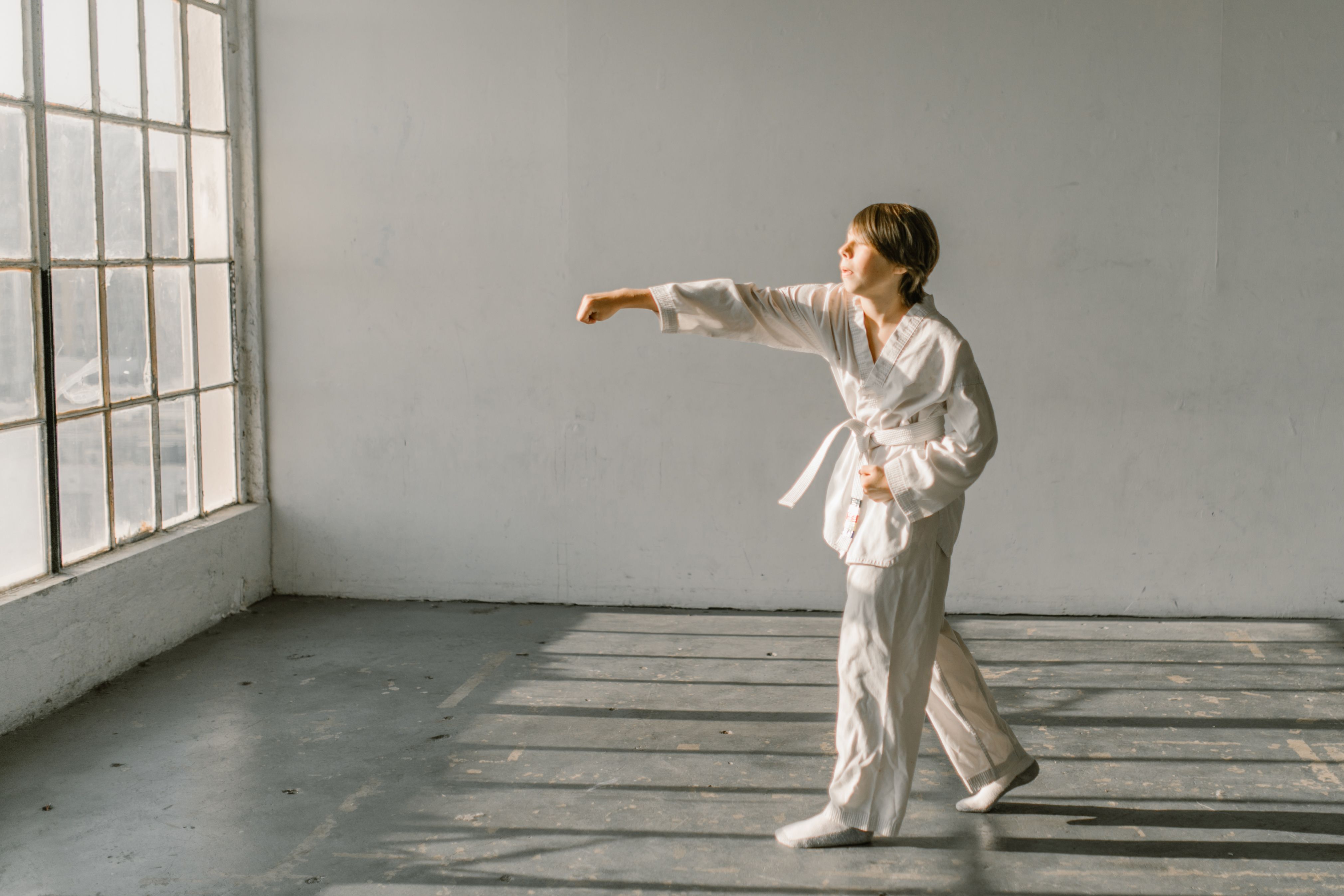 A Person Punching a Yellow Martial Arts Board · Free Stock Photo