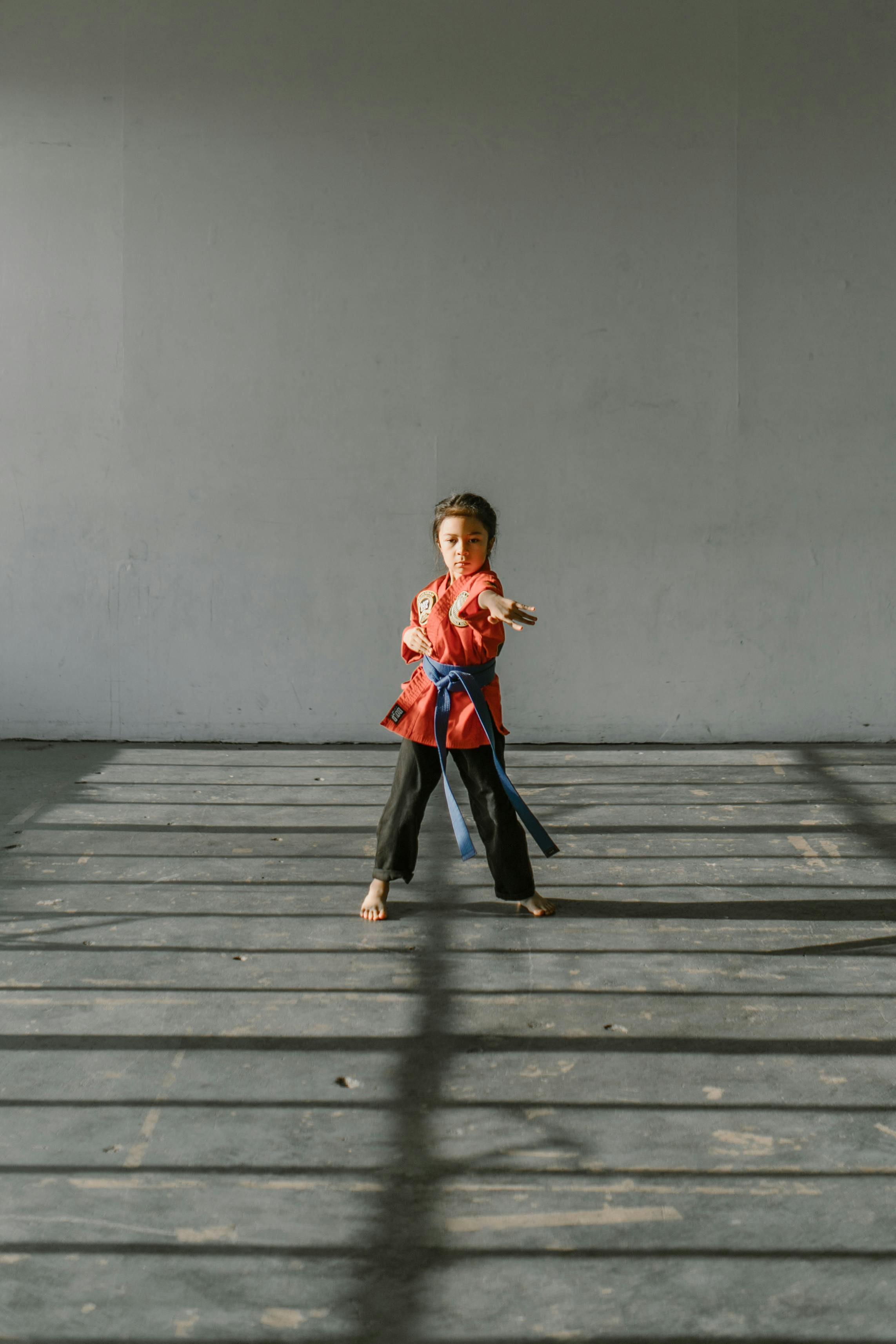 Girl Wearing Red Dobok and Blue Belt · Free Stock Photo