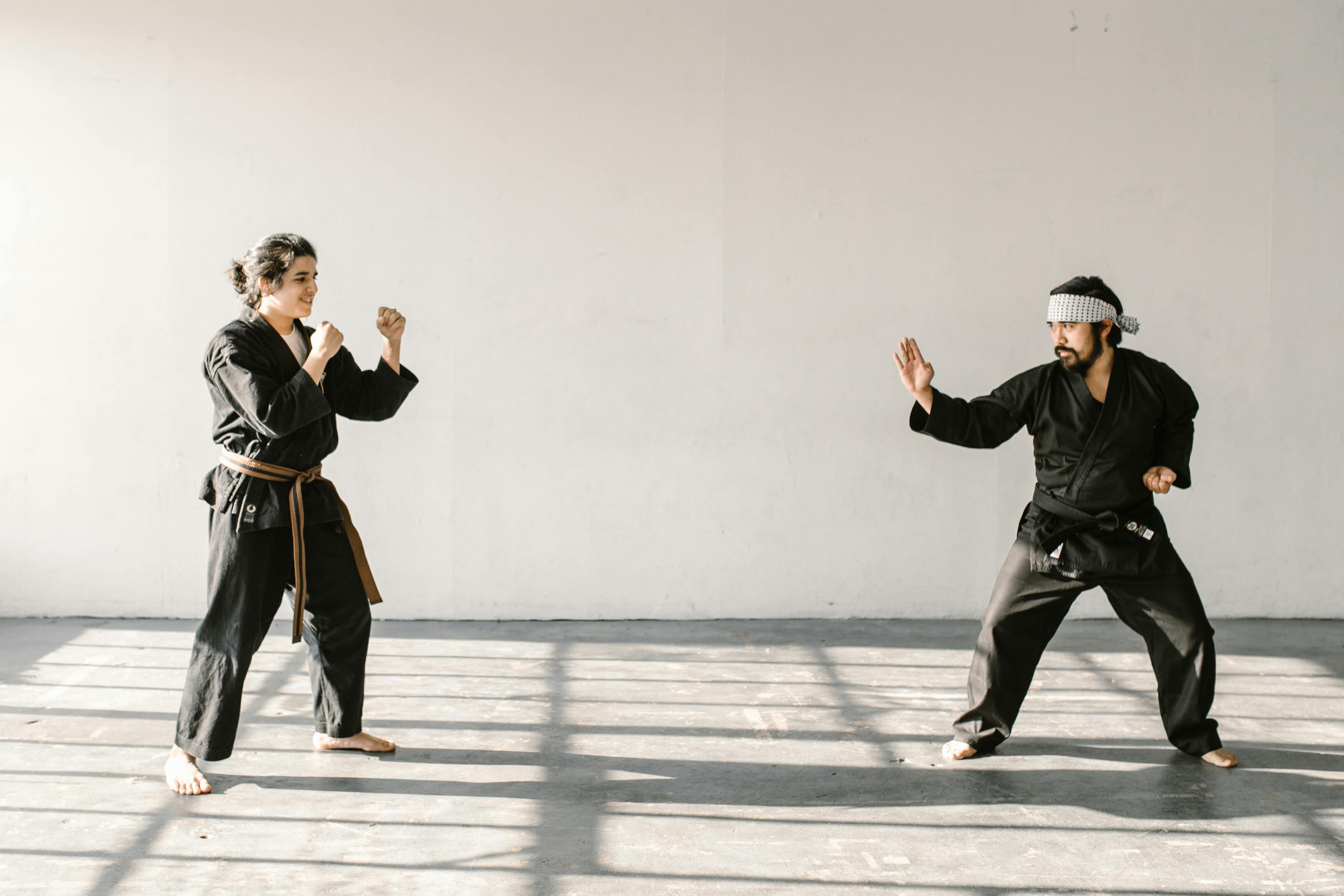 Man in Black Karate Uniform Holding a Stick · Free Stock Photo