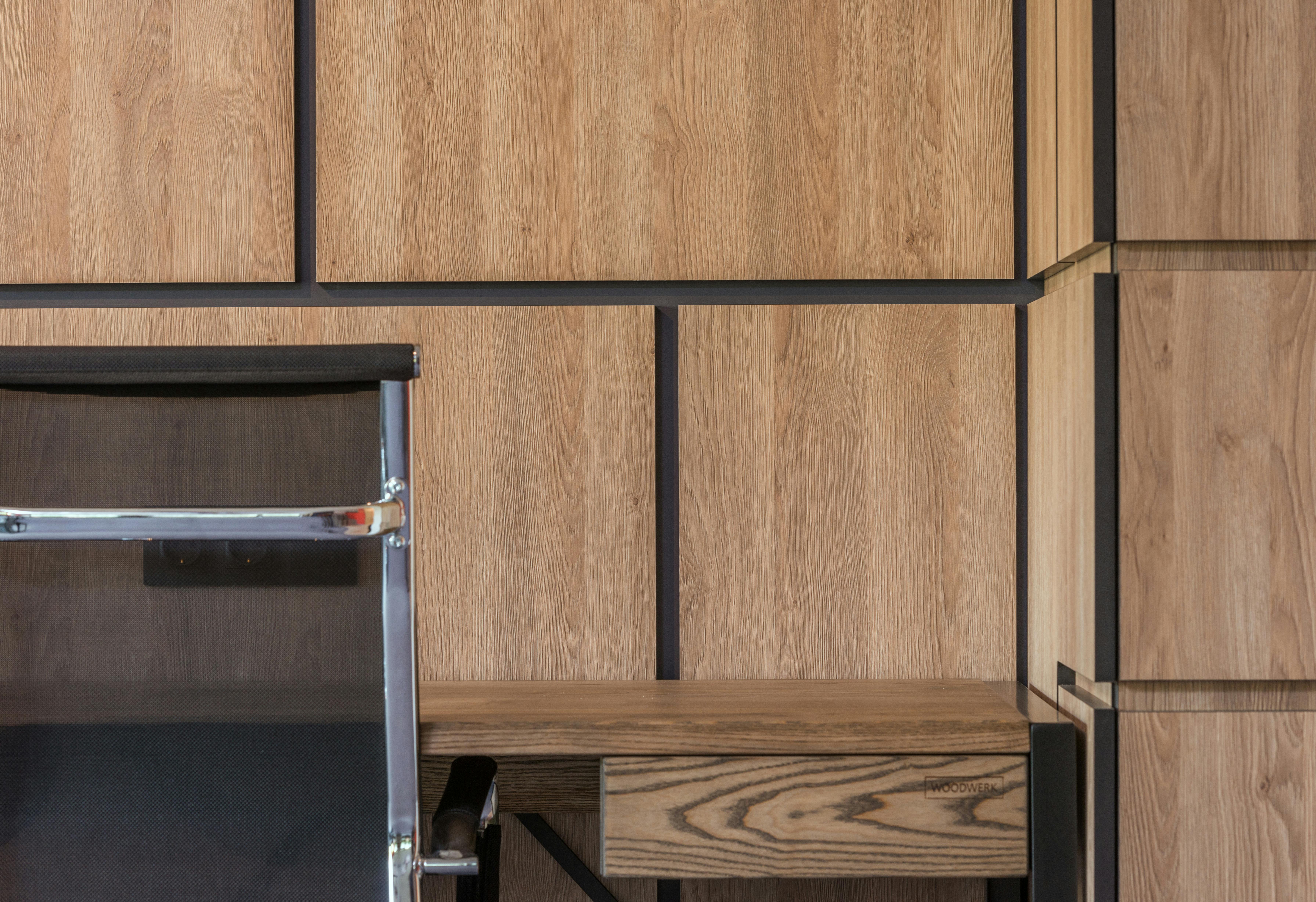 Wooden cabinet and chair placed at table in workroom · Free Stock Photo