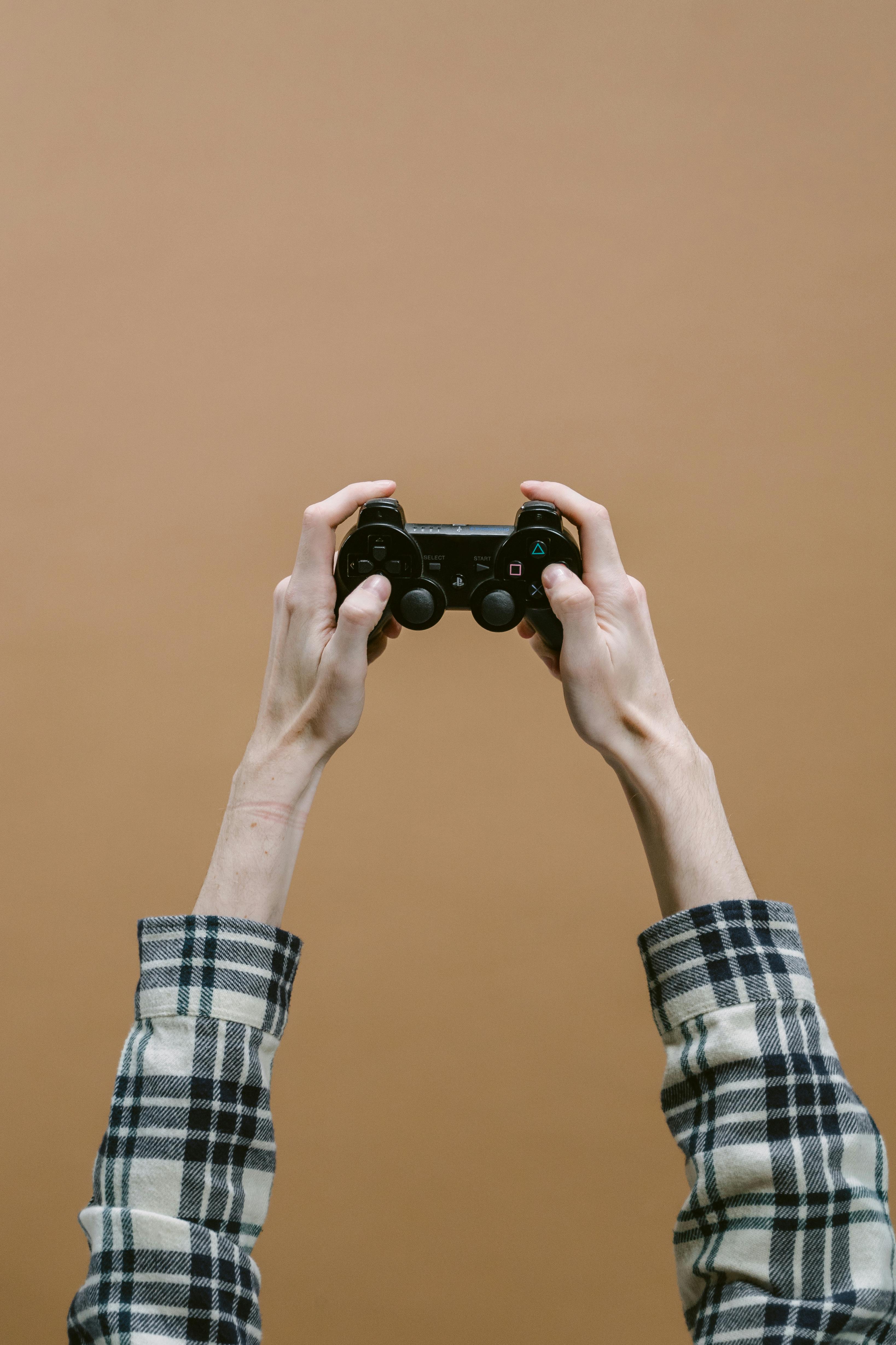 Person Holding Black Sony Ps 4 Game Controller · Free Stock Photo
