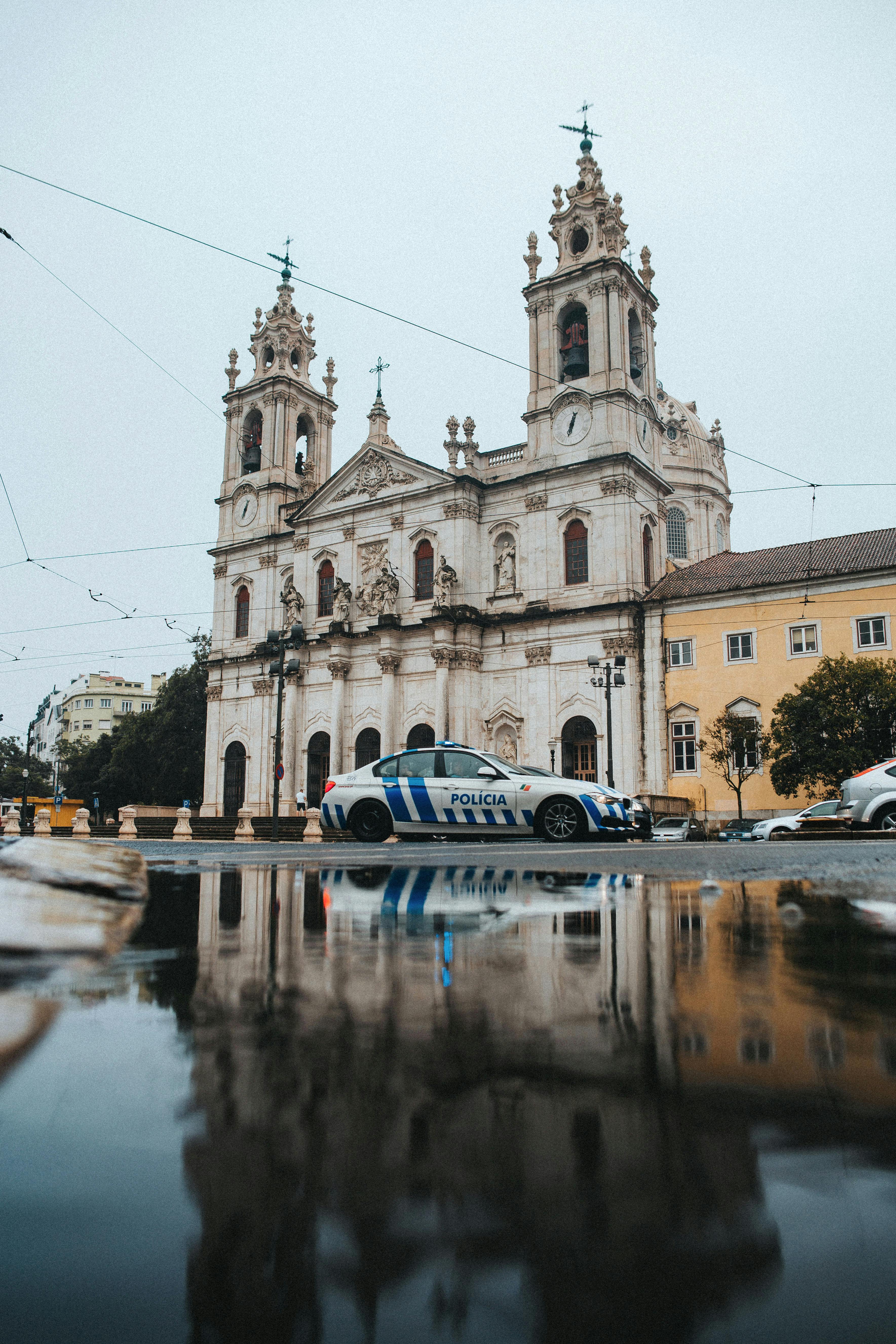 Police Car Near White Concrete Building · Free Stock Photo