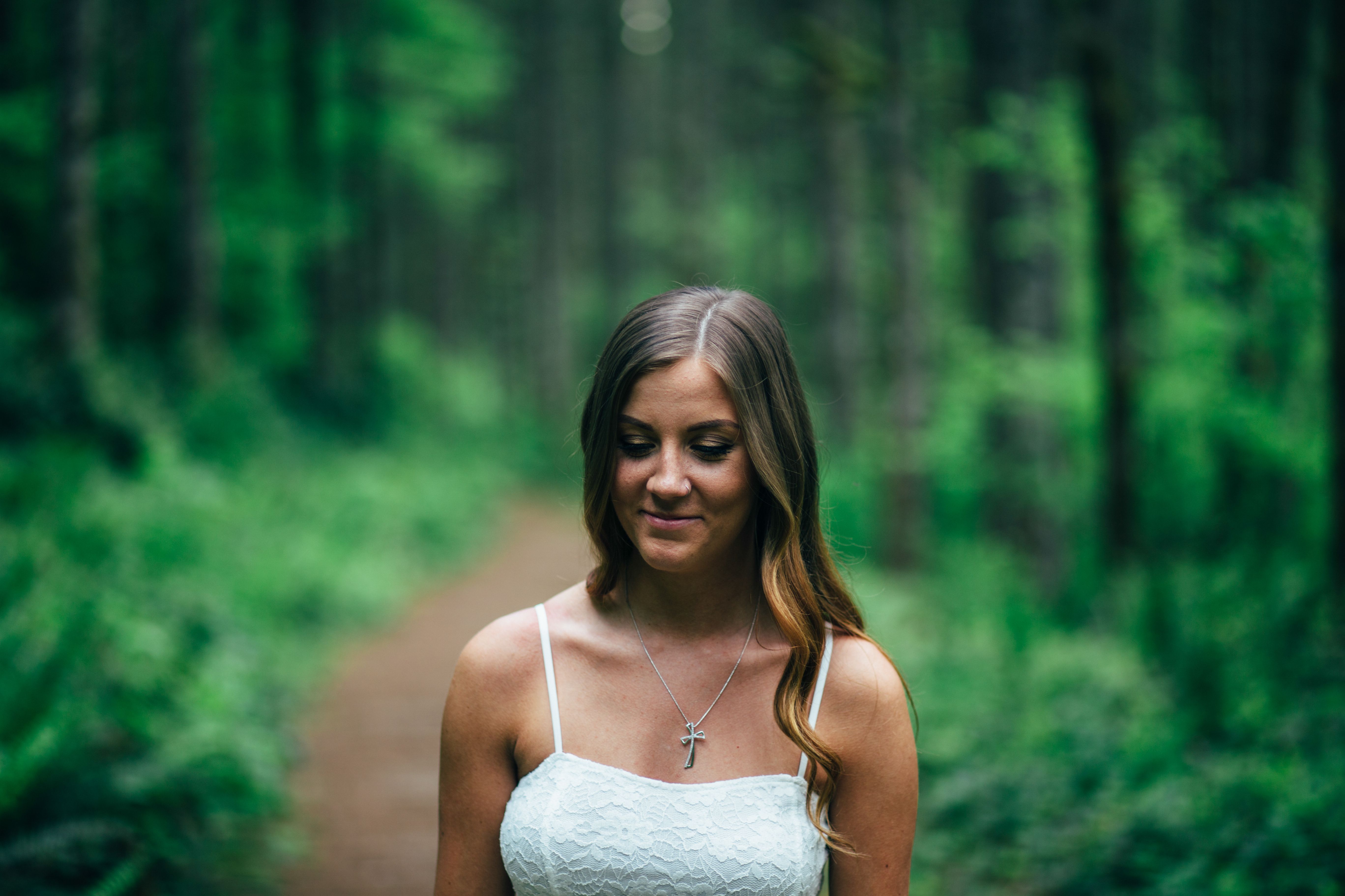 Woman Wearing Red Dress Holding Gray Wooden Fence · Free Stock Photo