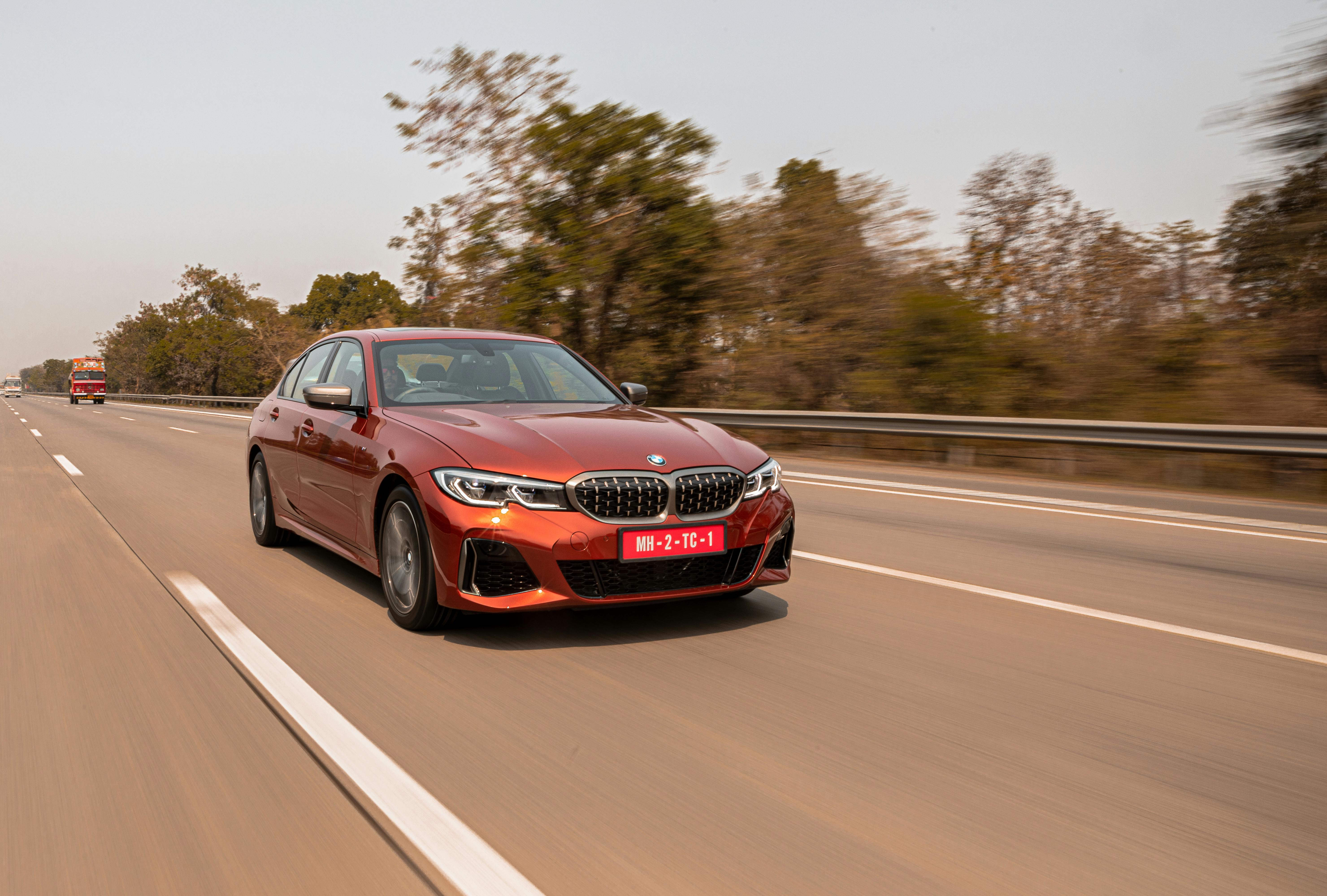 Red Car Driving on the Road · Free Stock Photo