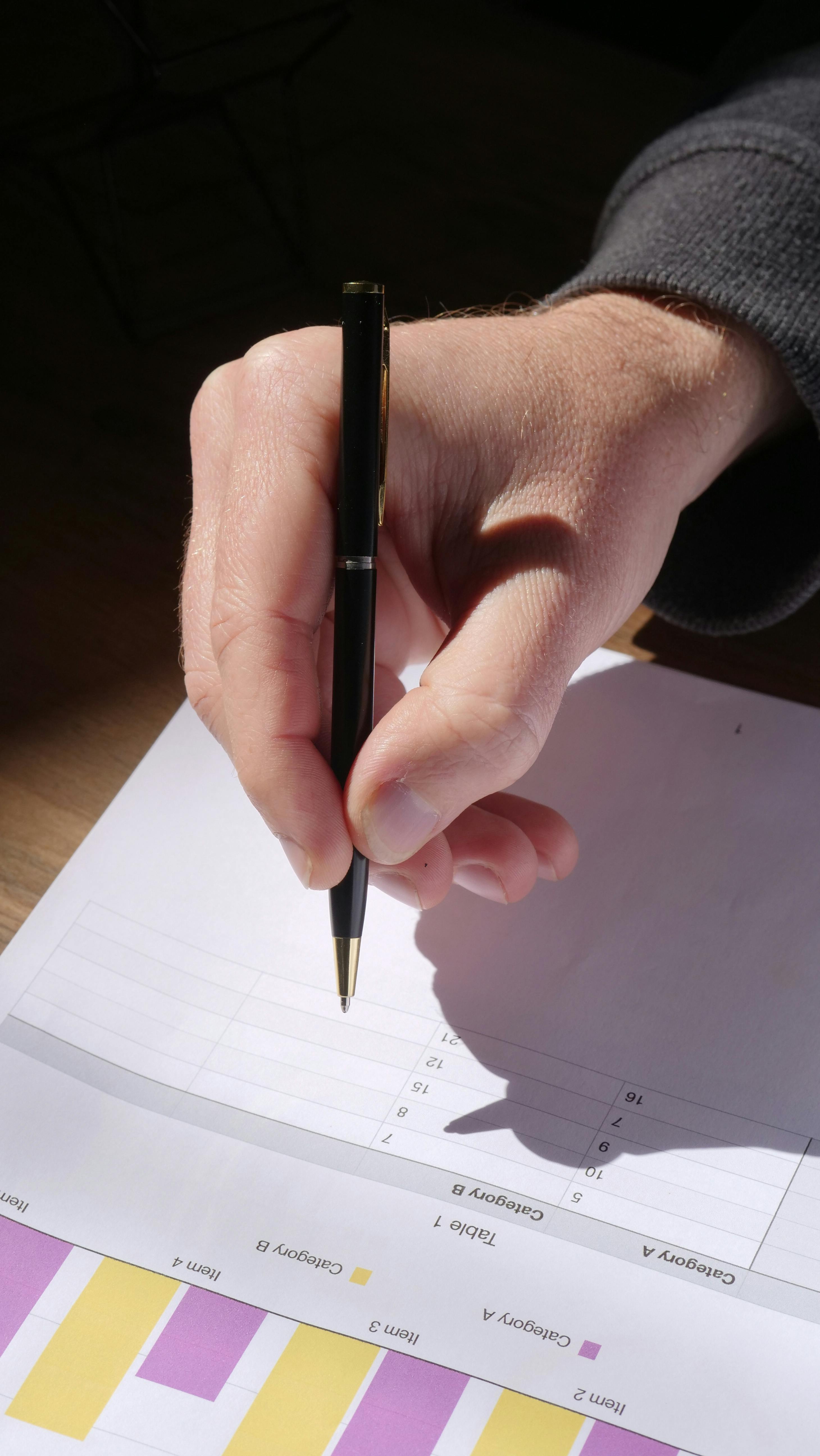 Person Using Black Pen · Free Stock Photo