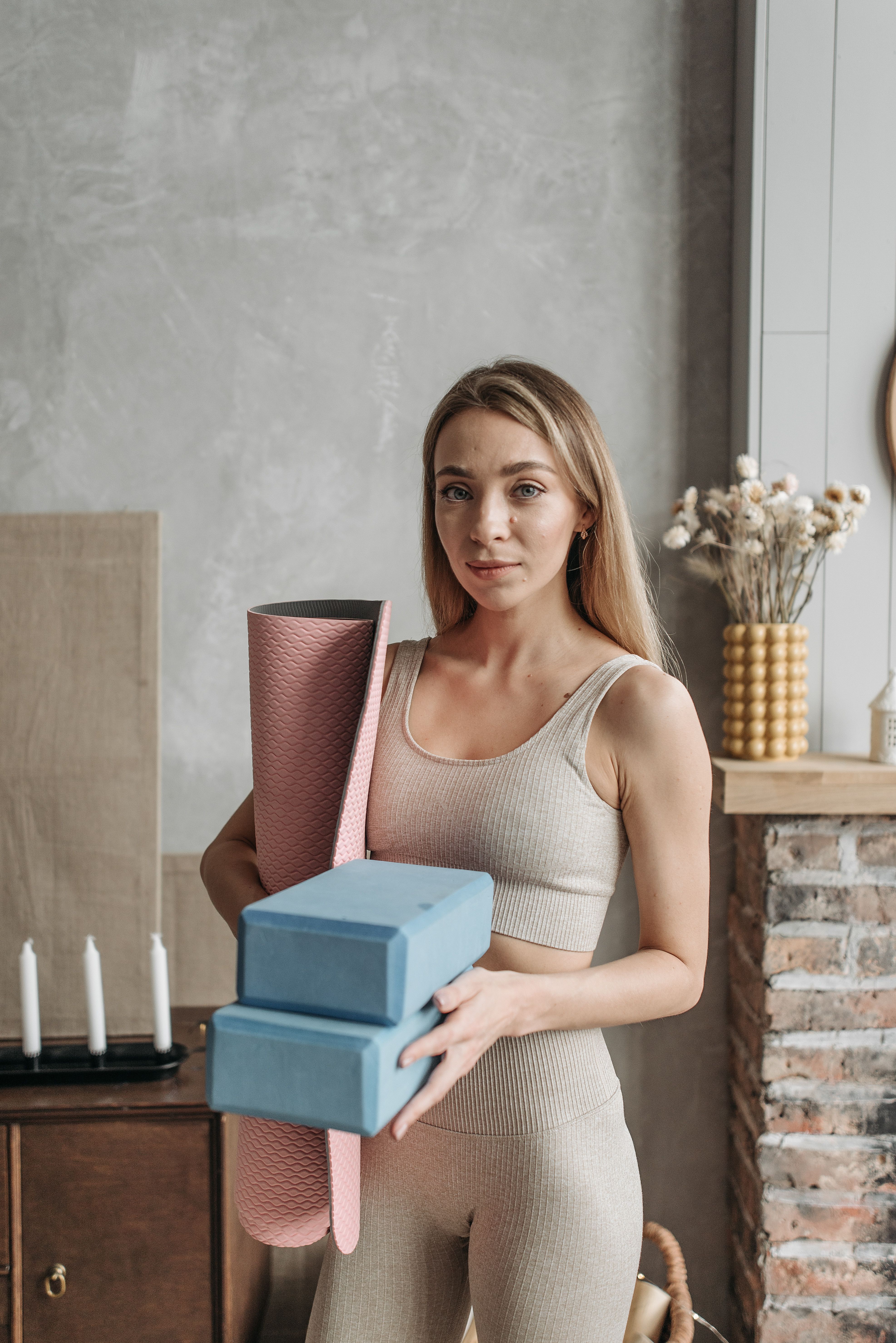 Woman Standing and Holding Blue Yoga Mat · Free Stock Photo