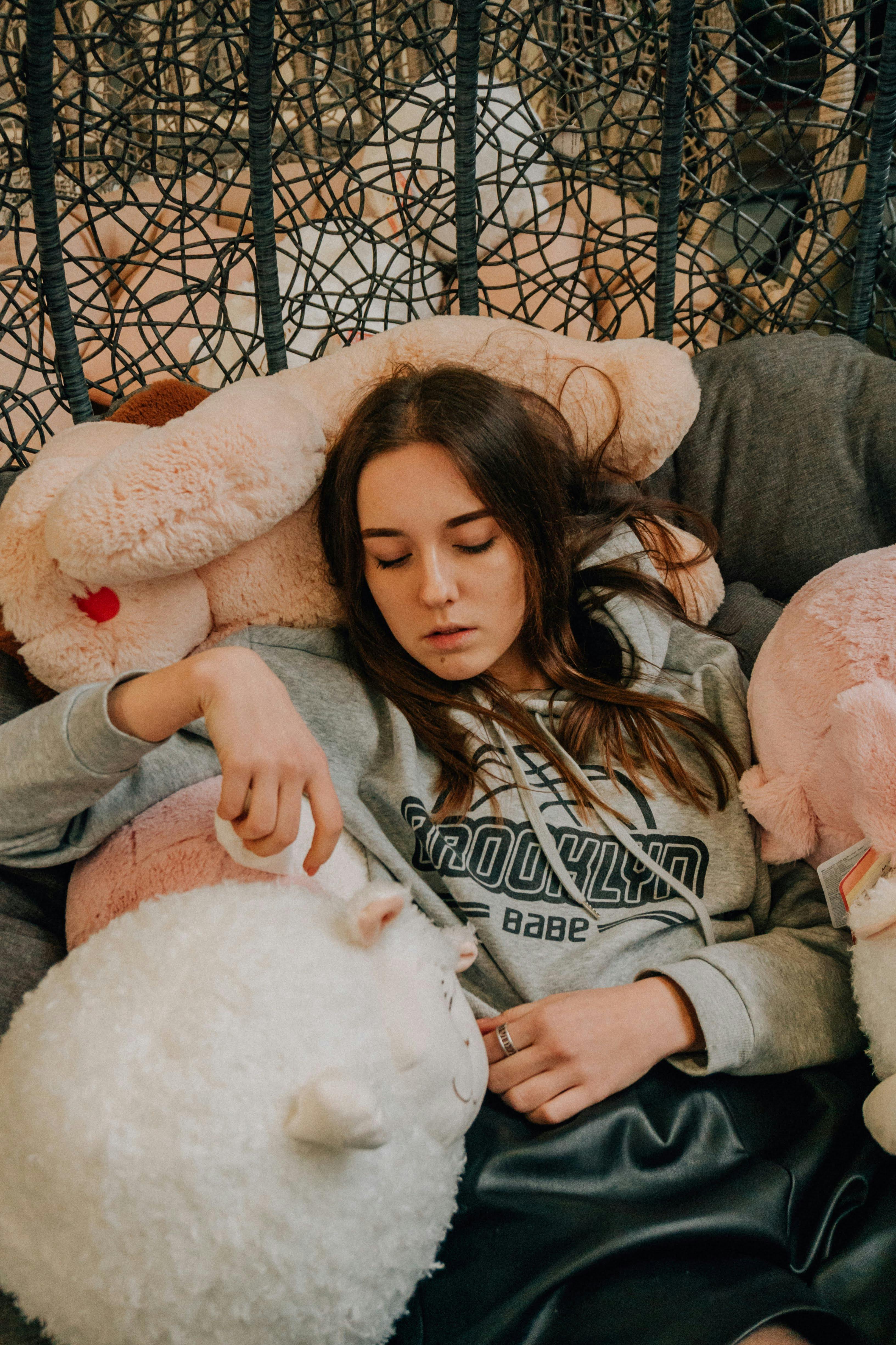 Woman resting with stuffed toys · Free Stock Photo