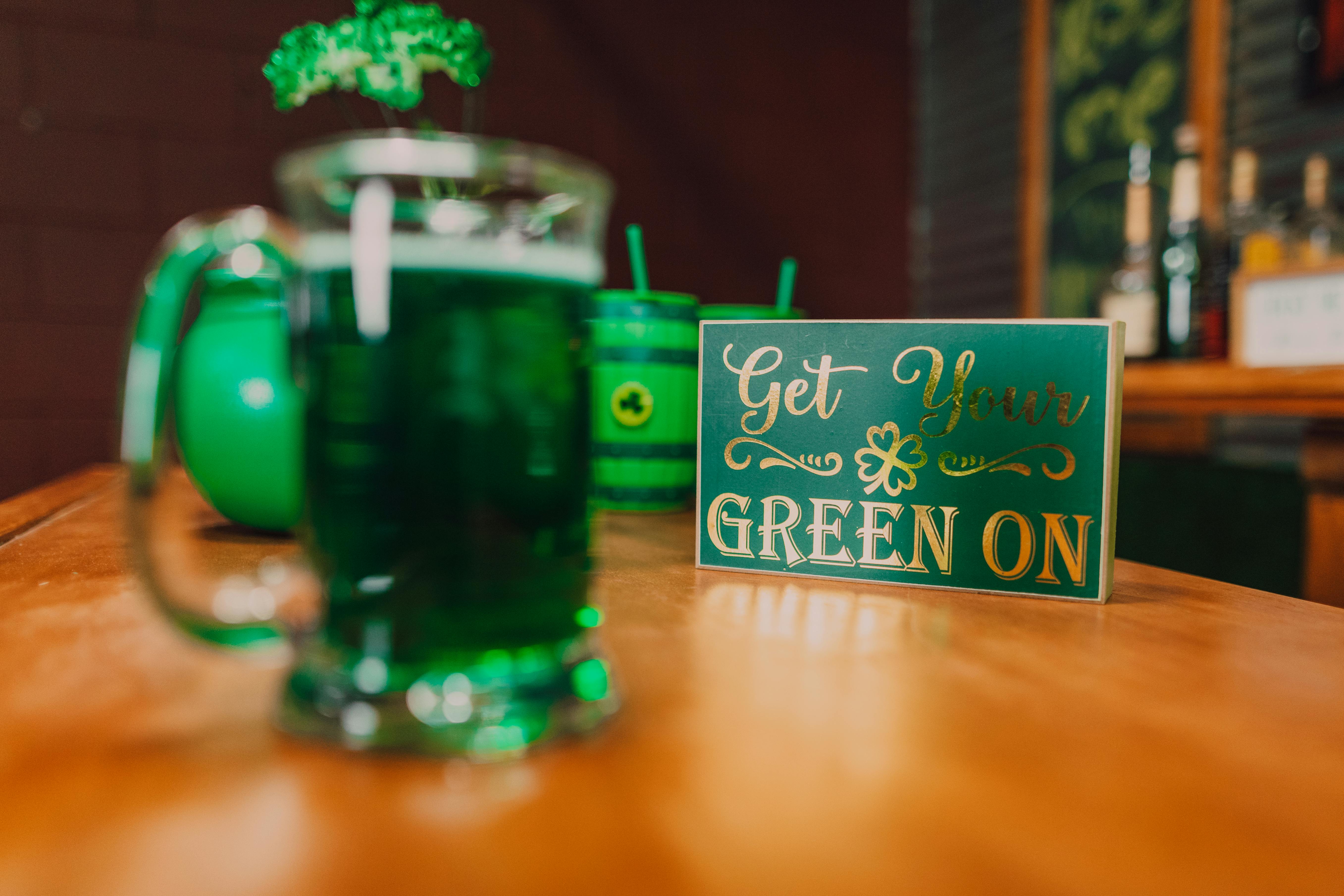 Signage Near a Clear Mug on a Wooden Surface · Free Stock Photo