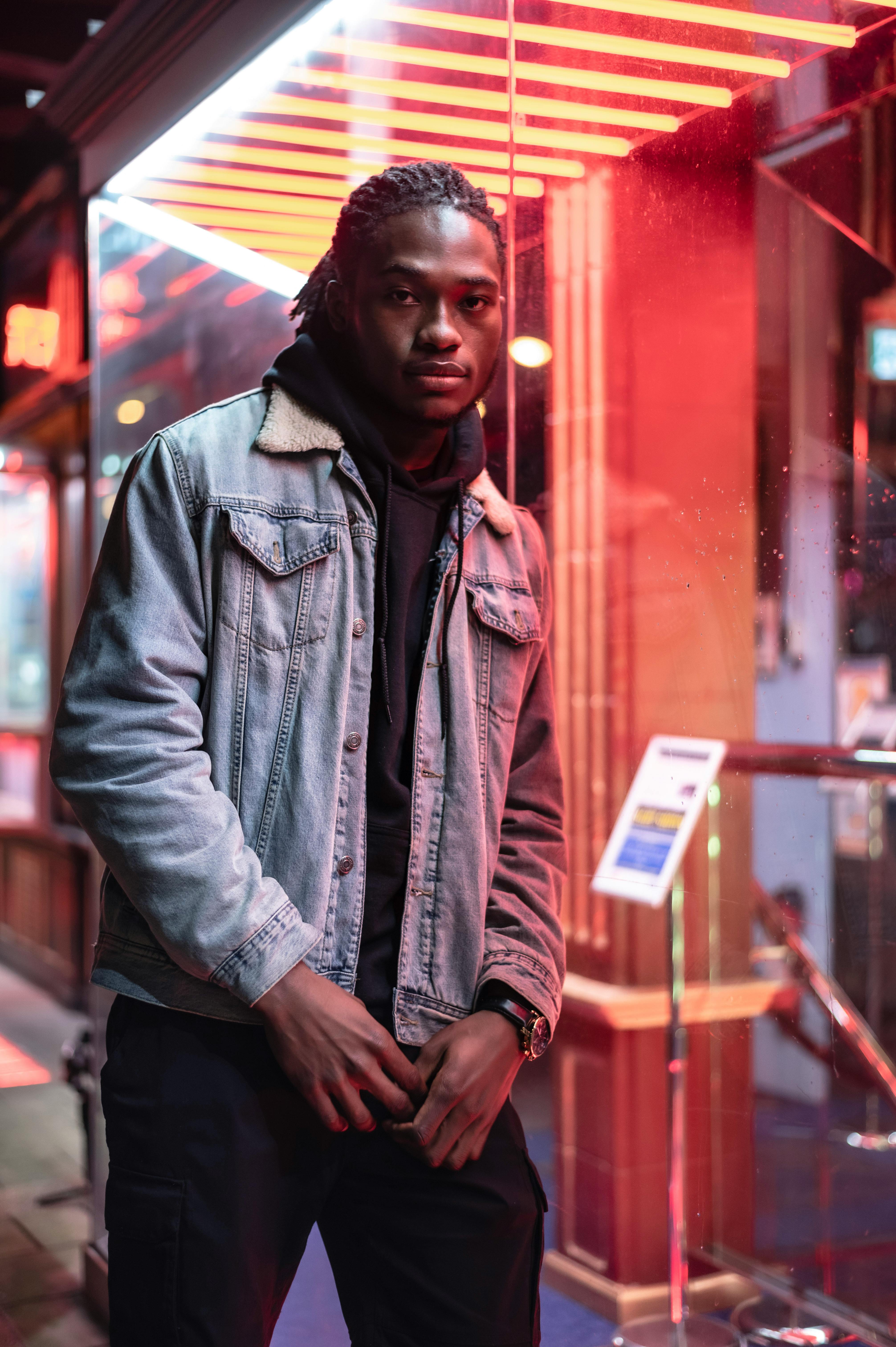 Stylish black man near glass wall of building · Free Stock Photo