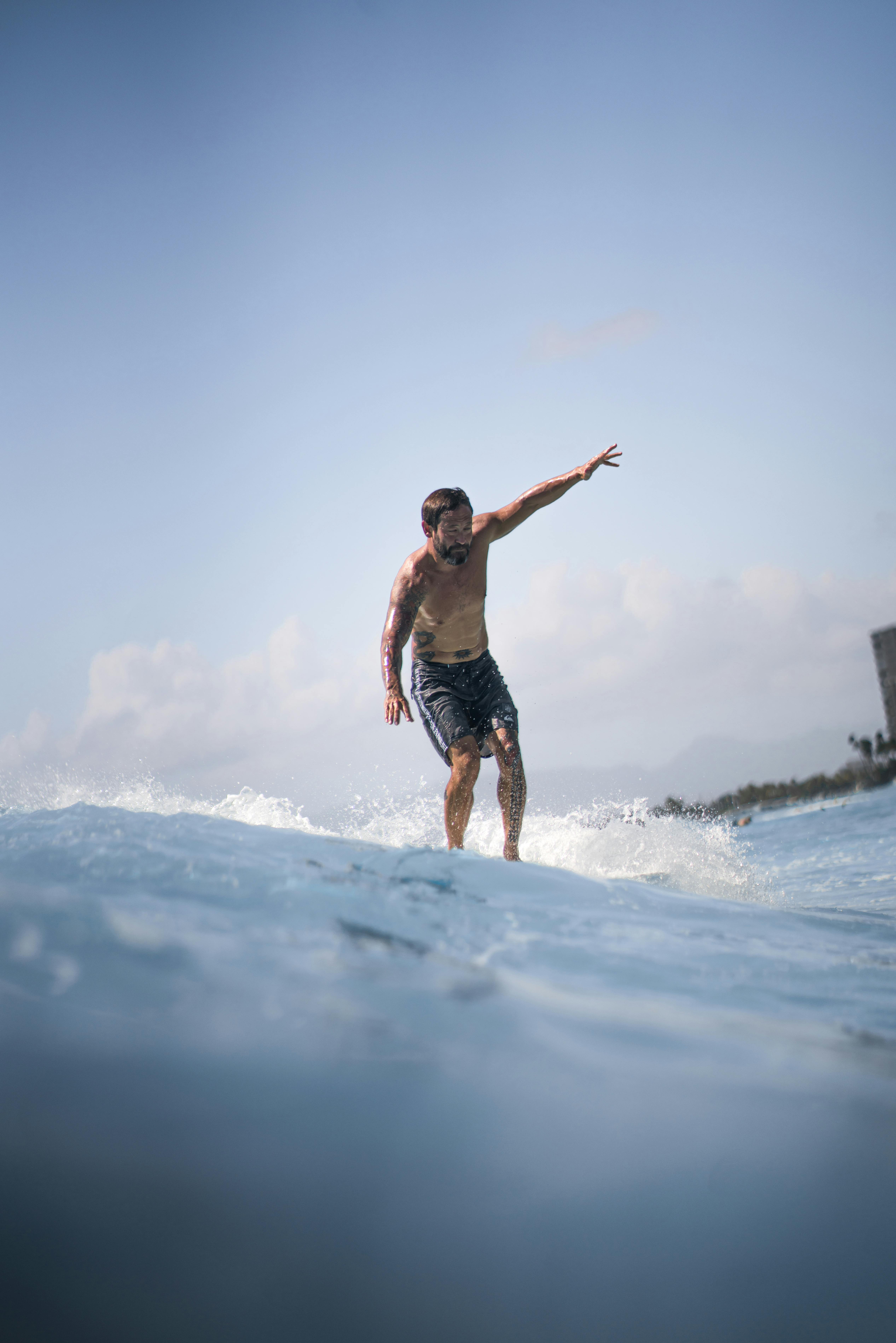 Shirtless man surfing in wavy sea · Free Stock Photo