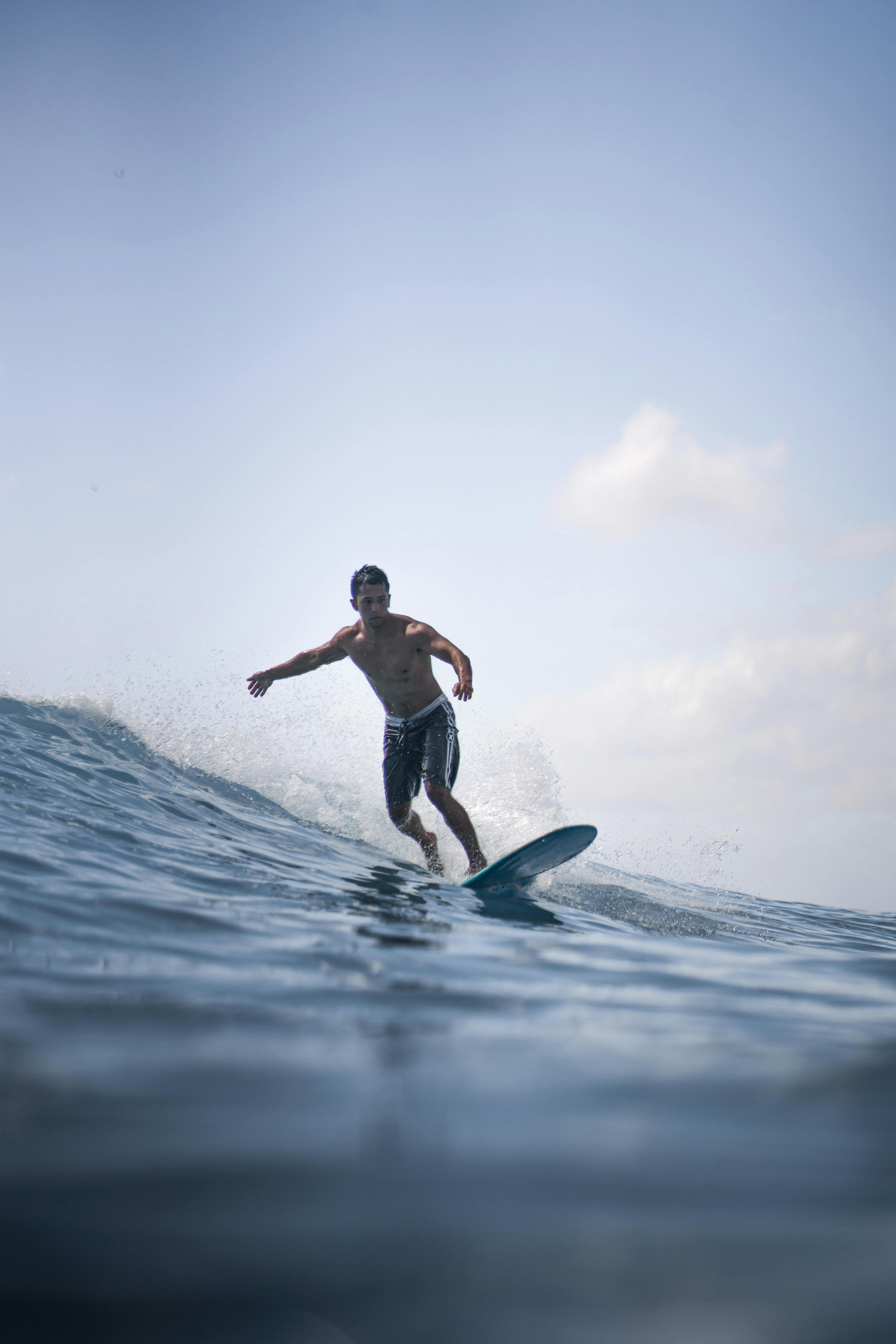 Strong surfer riding waves in sea · Free Stock Photo