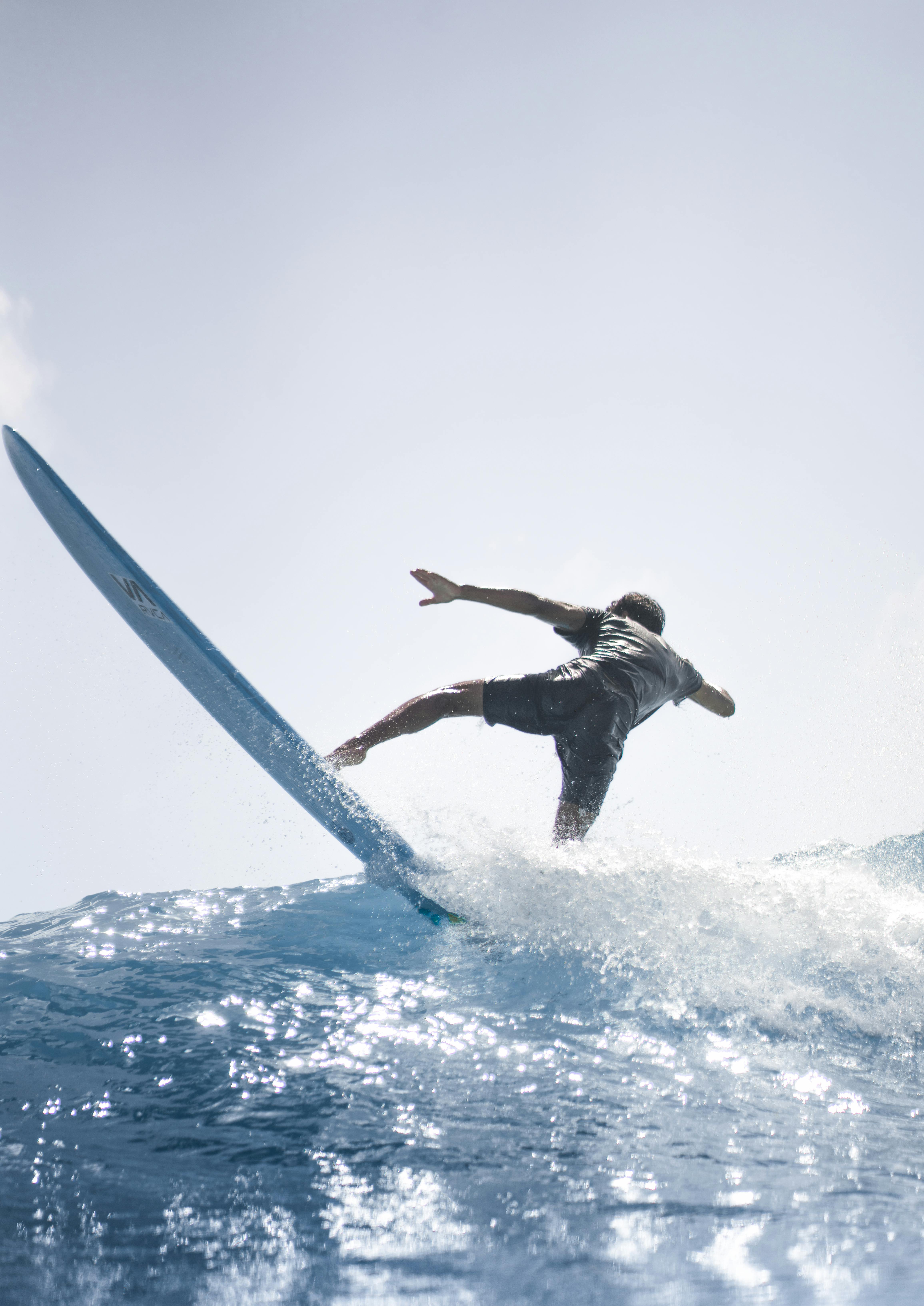 A Surfer Riding Waves at Sea · Free Stock Photo