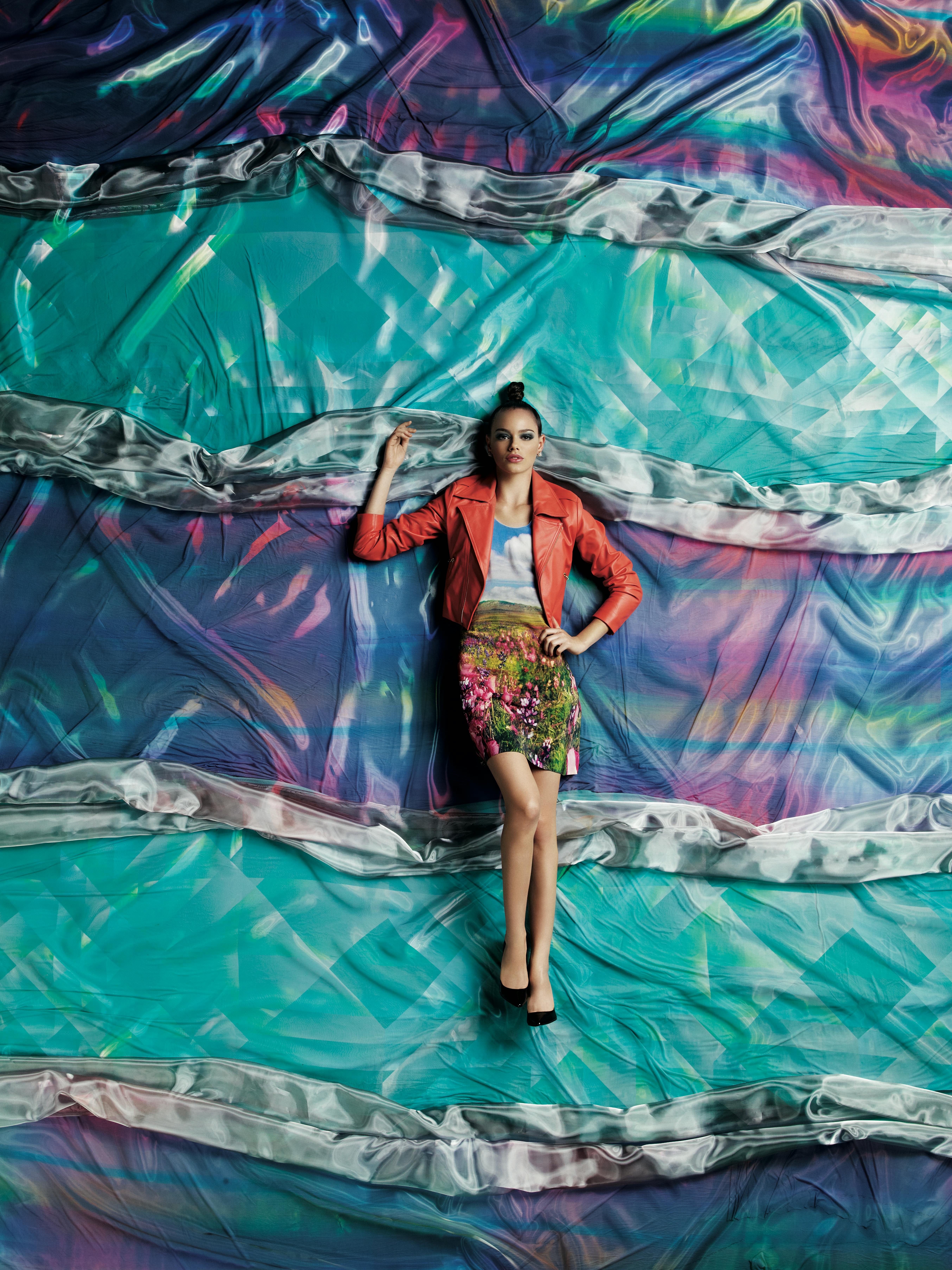 High-Angle Shot of a Model Lying on Colorful Textile · Free Stock Photo