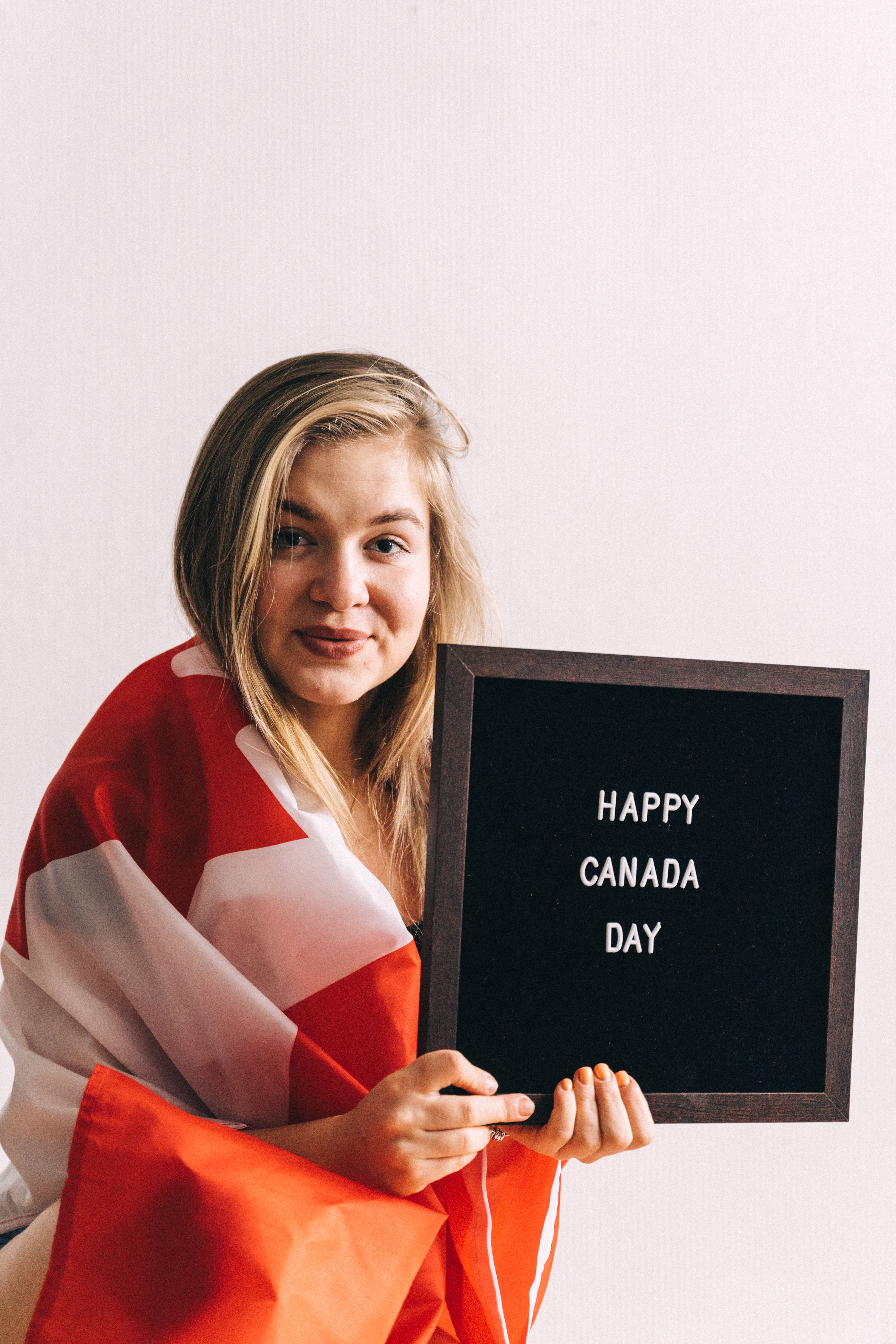 Photo of Woman wrapped with Candian Flag · Free Stock Photo