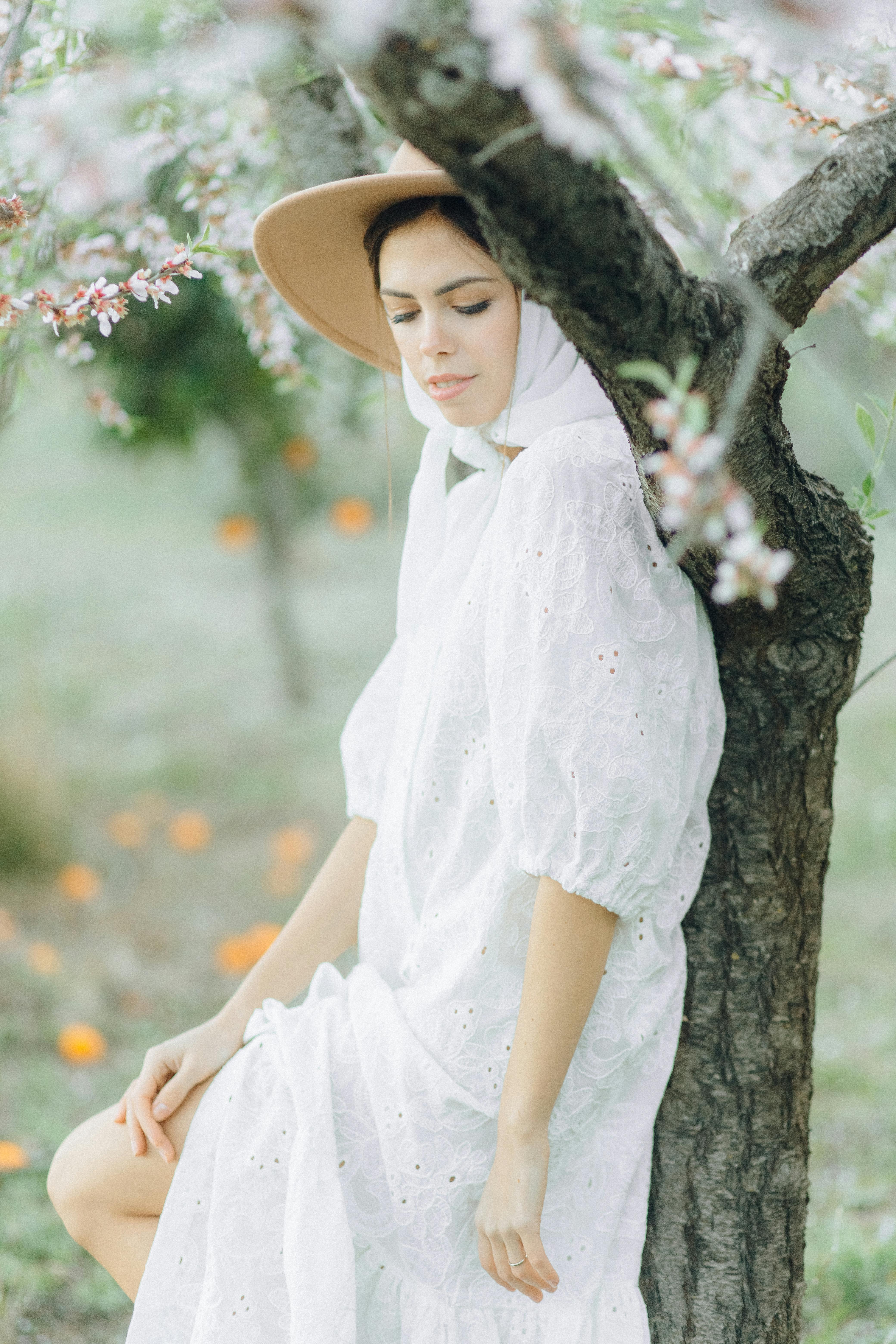 Woman in White Dress Leaning on Tree Trunk · Free Stock Photo