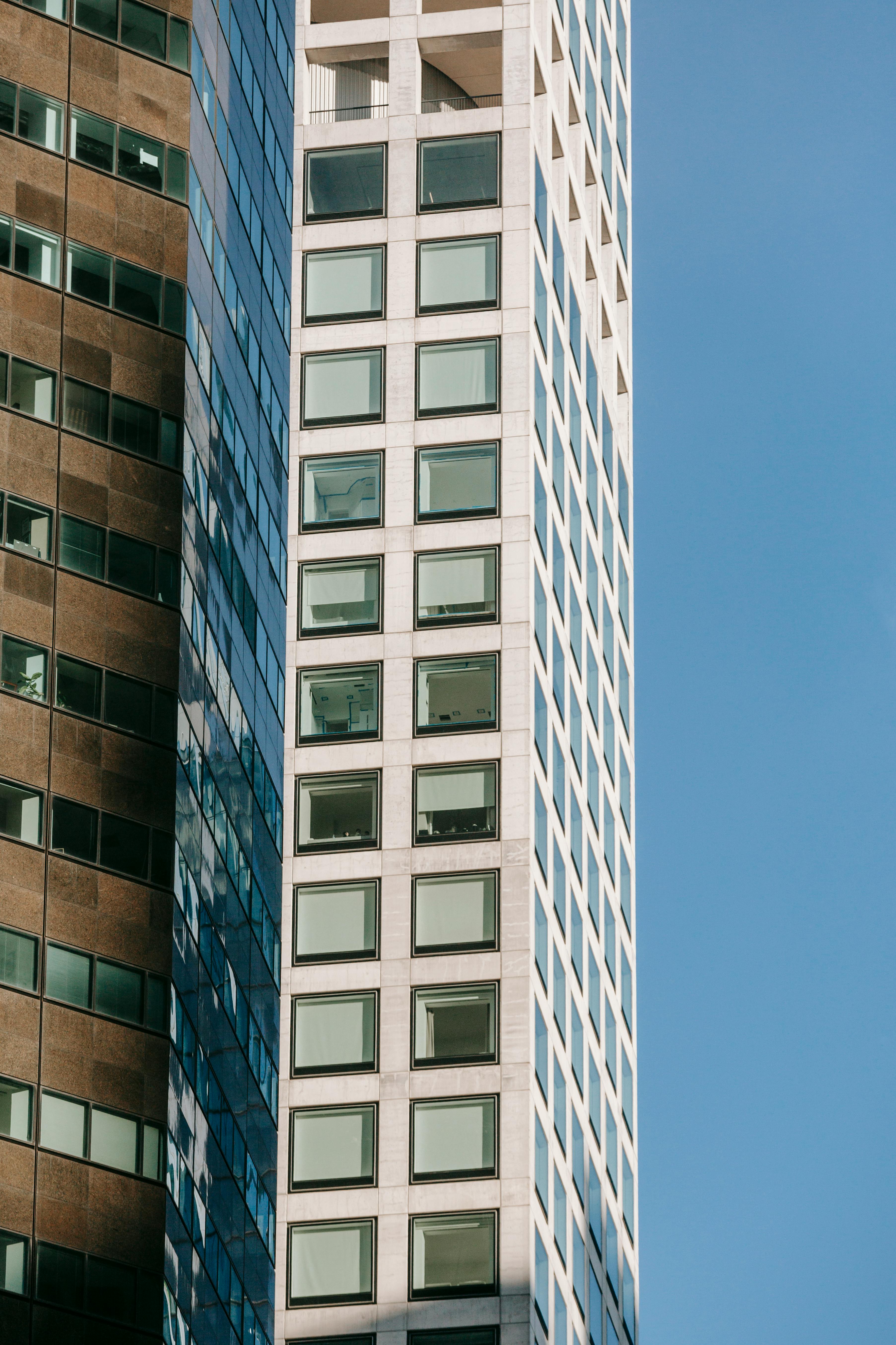Modern skyscraper facades with shade in city · Free Stock Photo