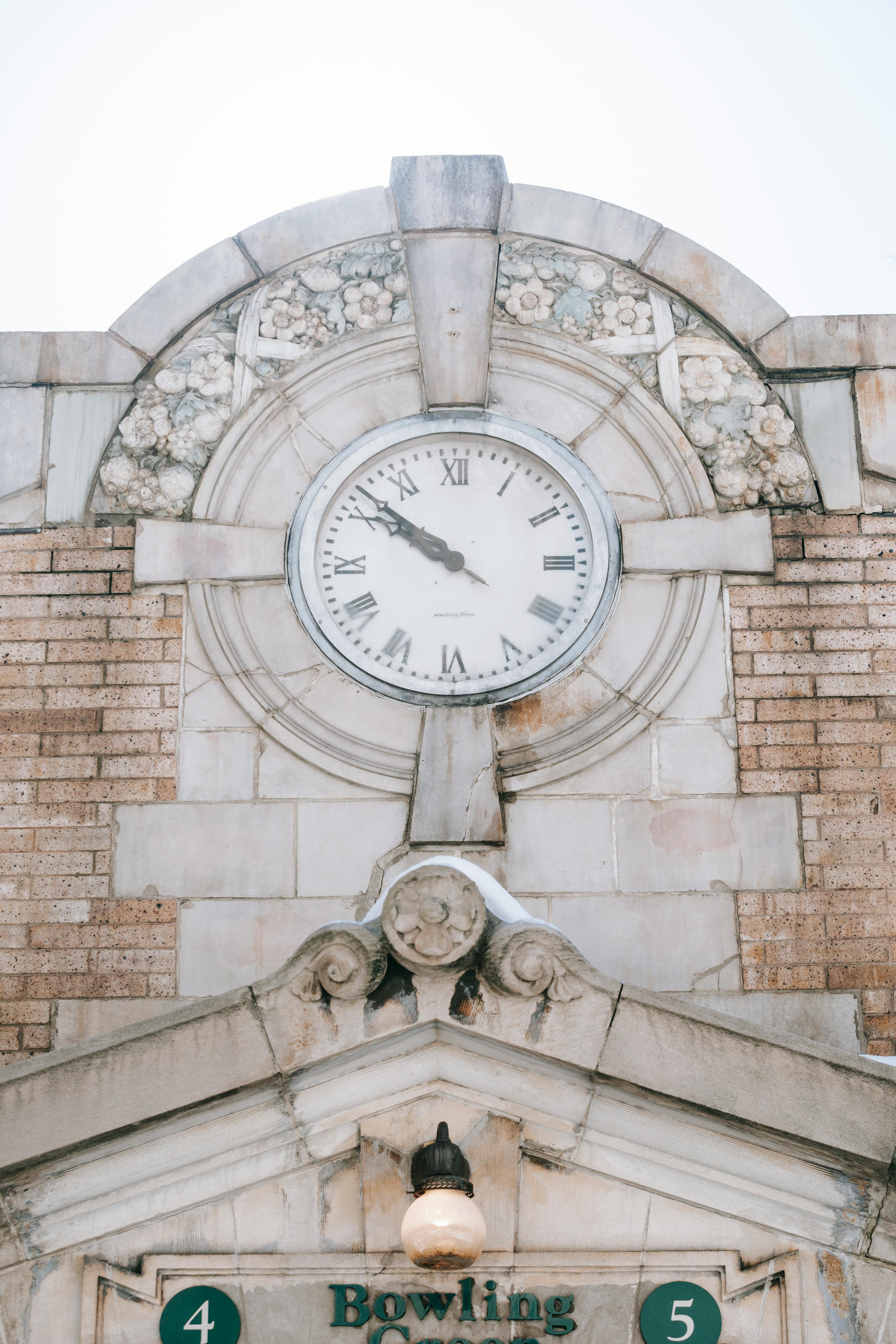 Old clock on stone building facade · Free Stock Photo