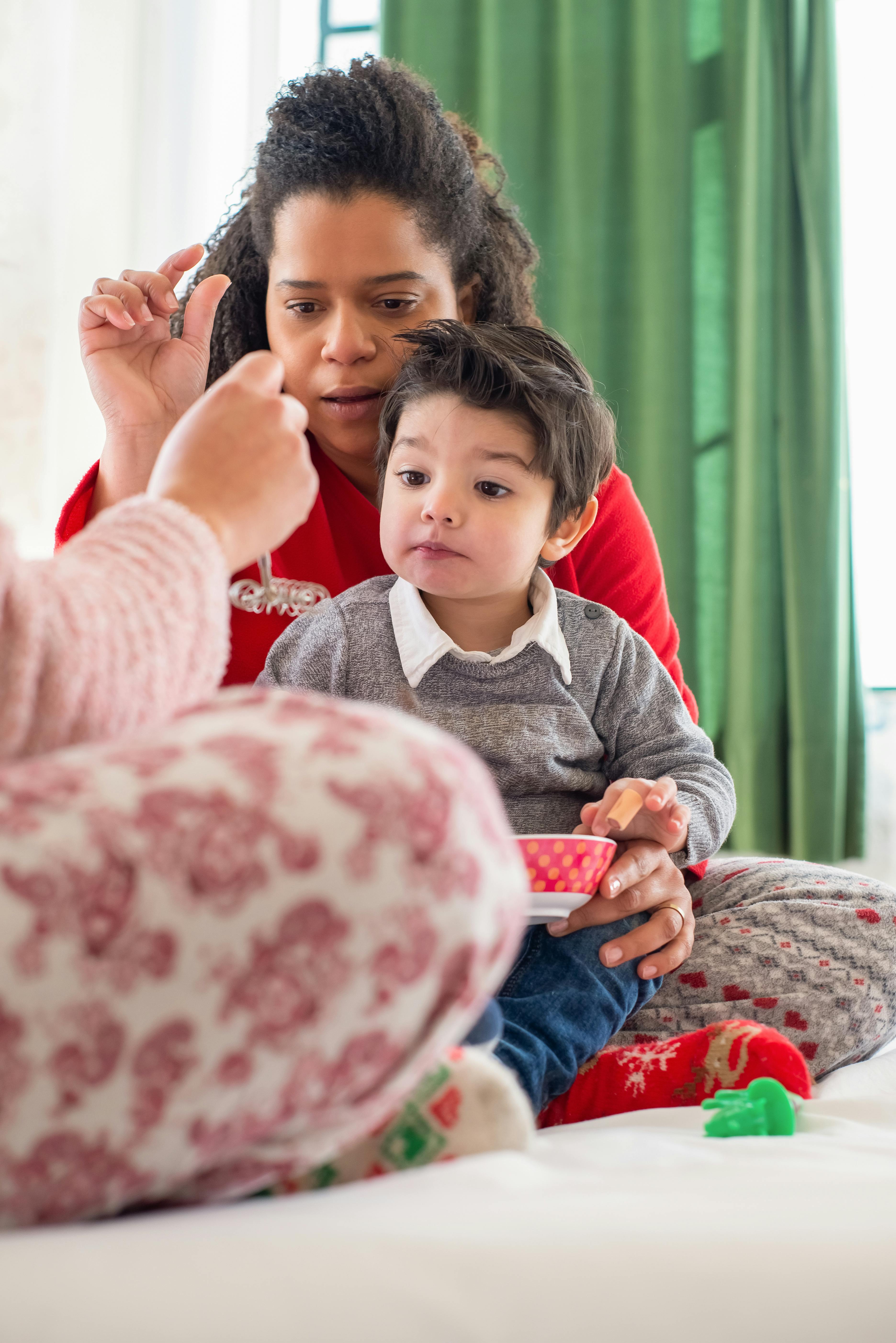 A Toddler Sitting on Parent's Lap · Free Stock Photo