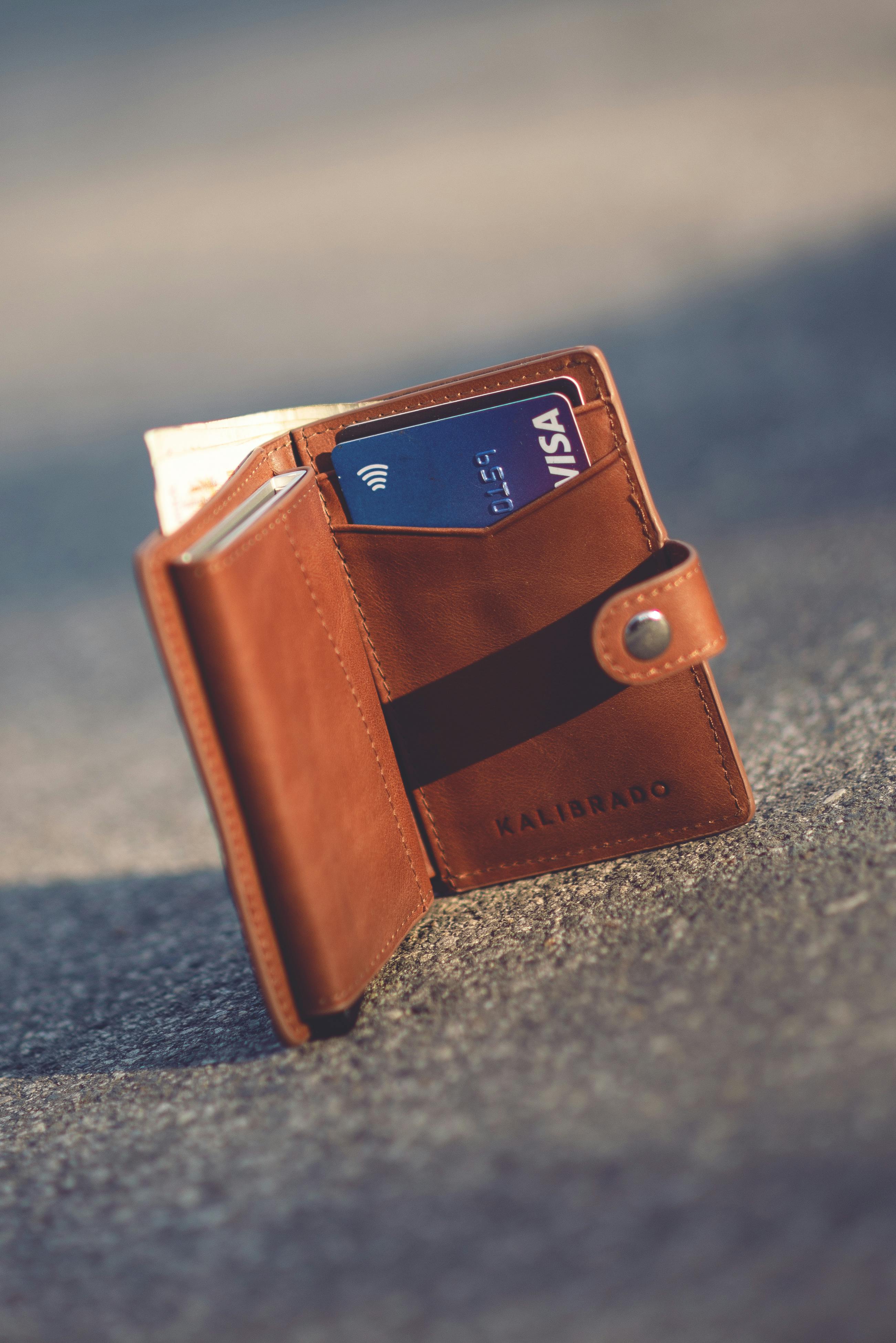 Person Closing a Brown Leather Wallet · Free Stock Photo