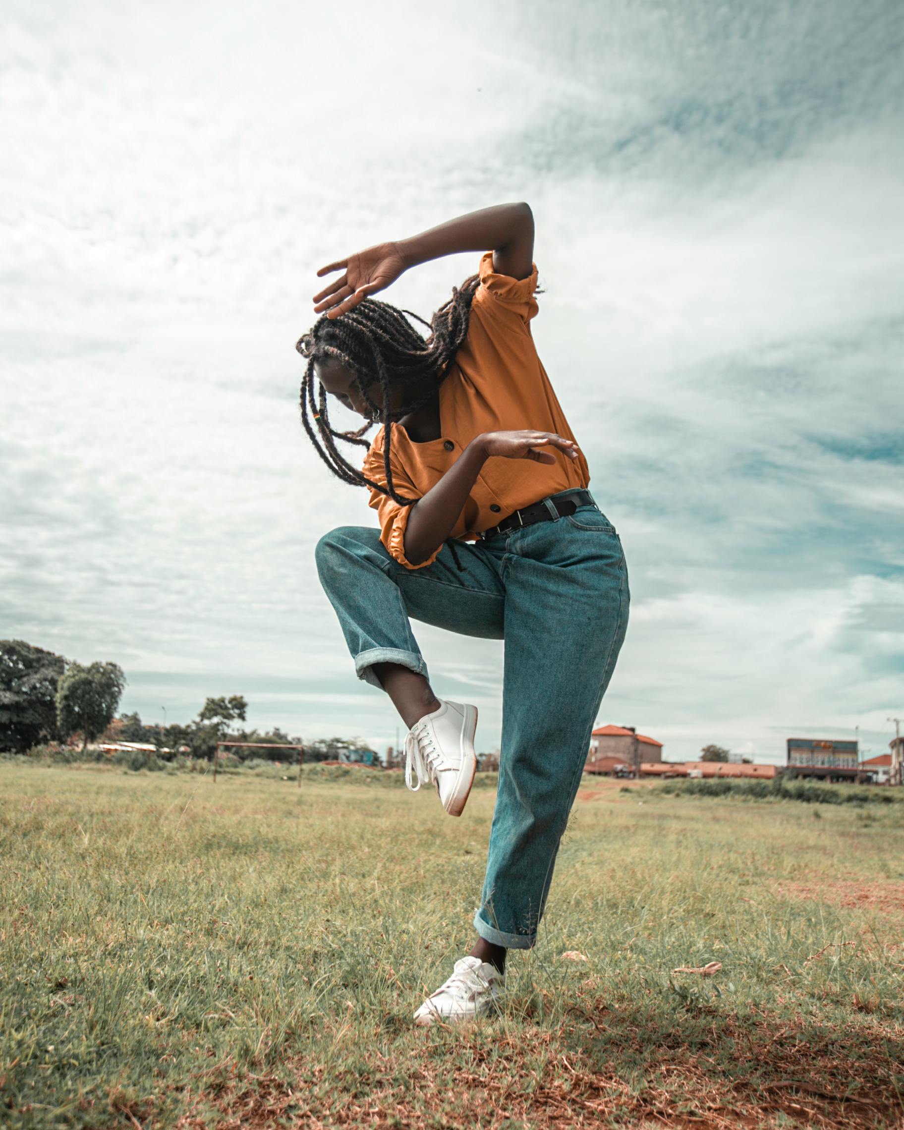 Woman Dancing while on a Grass Field · Free Stock Photo