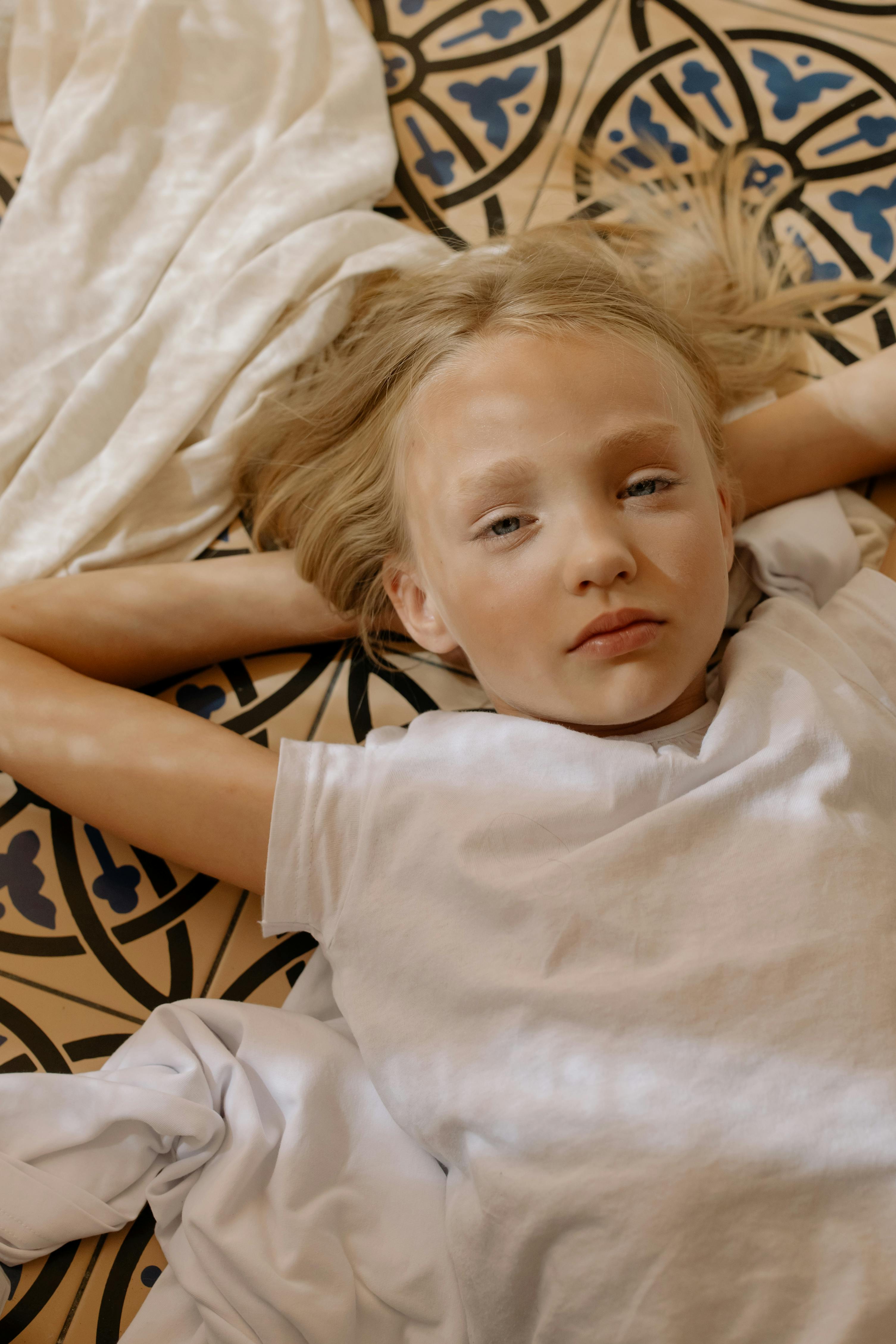 A Young Girl Lying Down on the Beach · Free Stock Photo