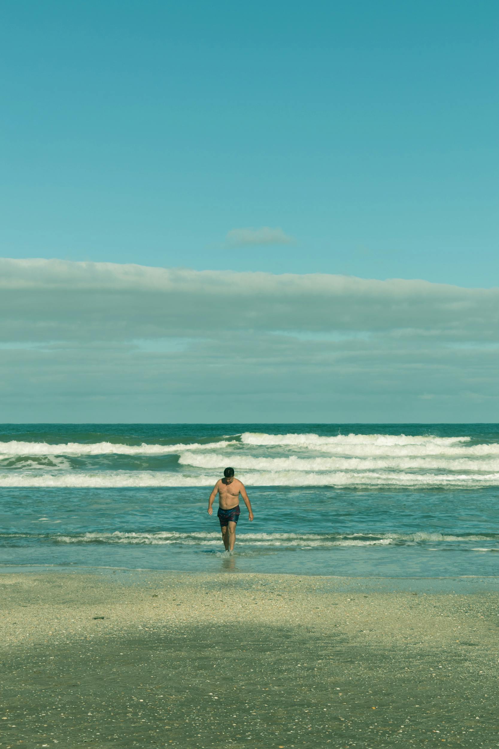 Man Walking Through Passage Between Rocks · Free Stock Photo