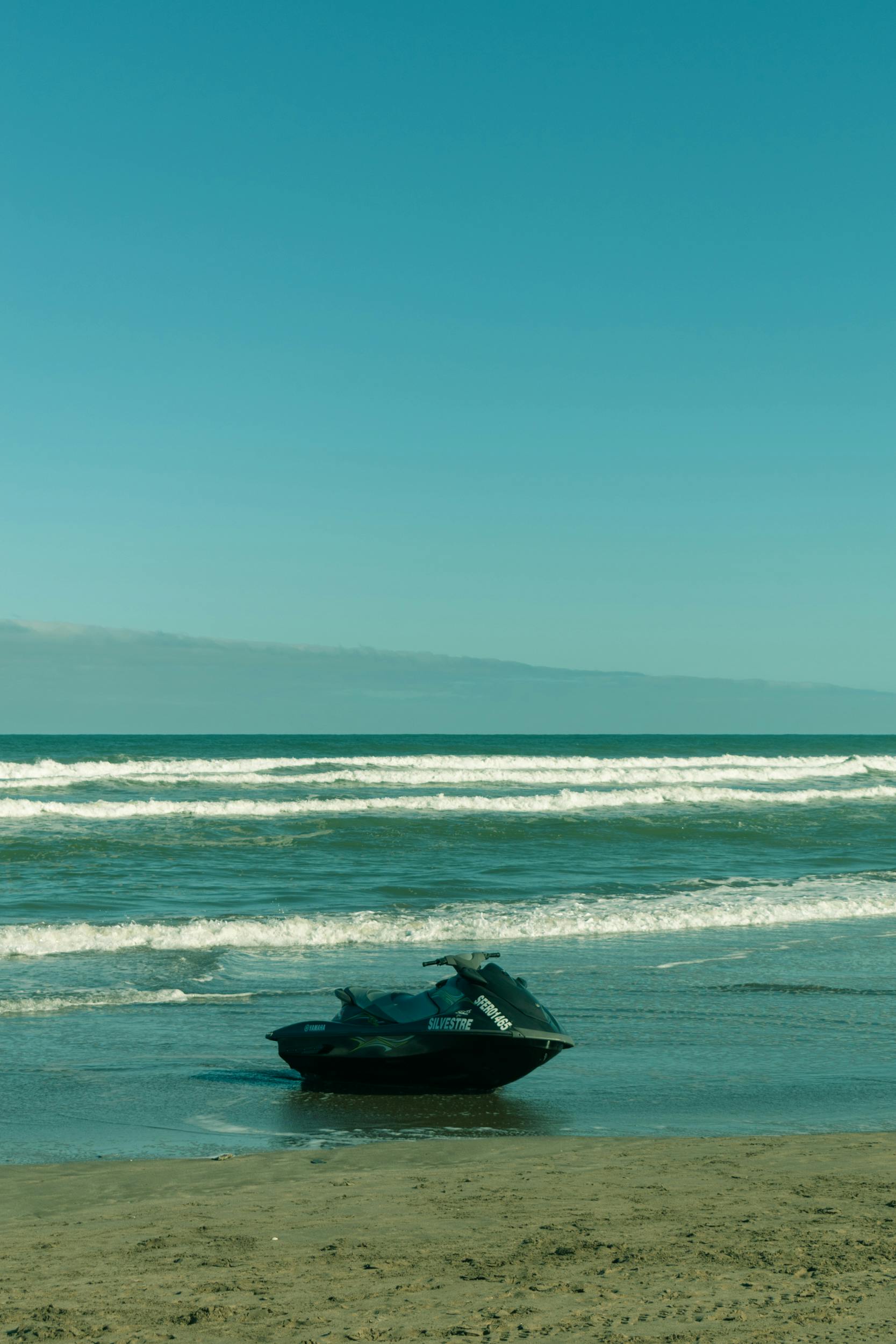 Empty Yellow and Black Jet Ski in Teal Sea Water · Free Stock Photo