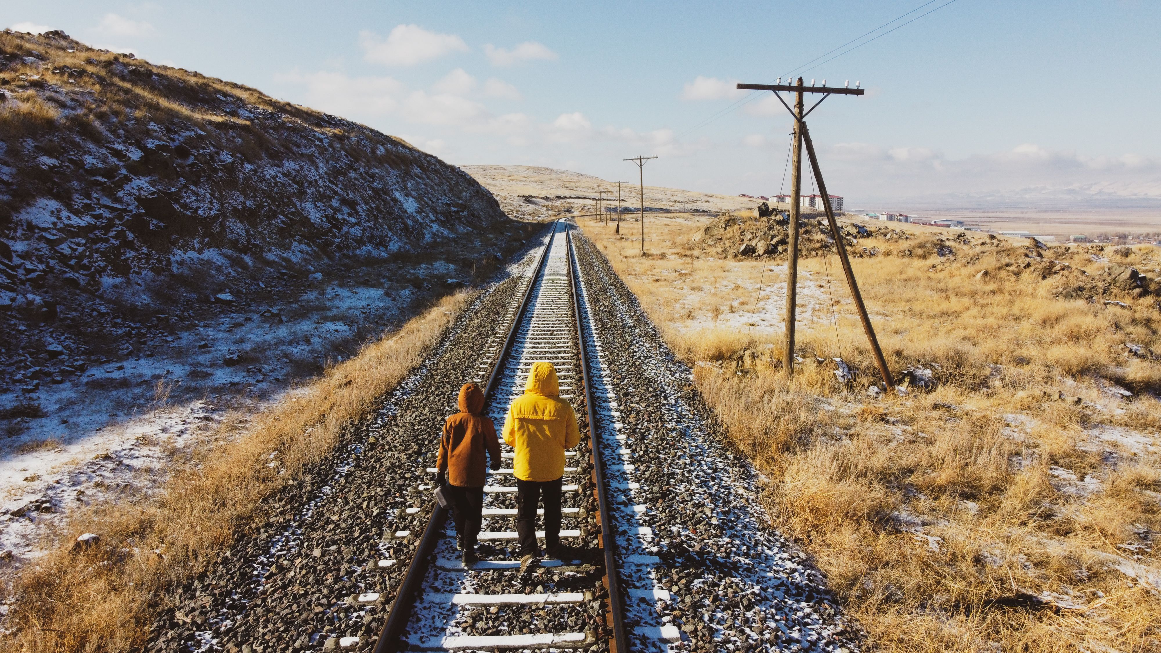 Two People Walking on the Railroad · Free Stock Photo