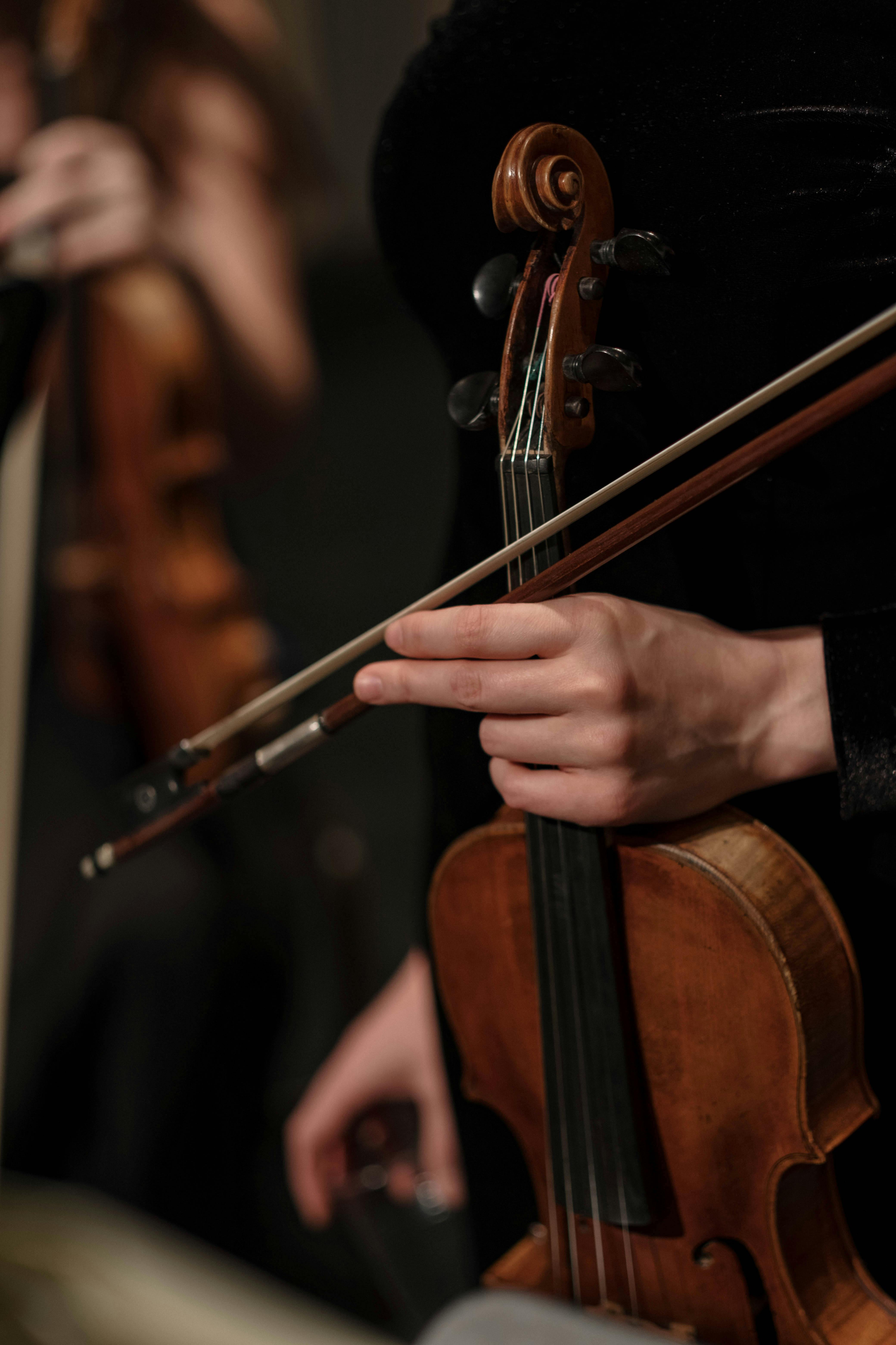 Close-Up Shot of a Person Playing Violin · Free Stock Photo