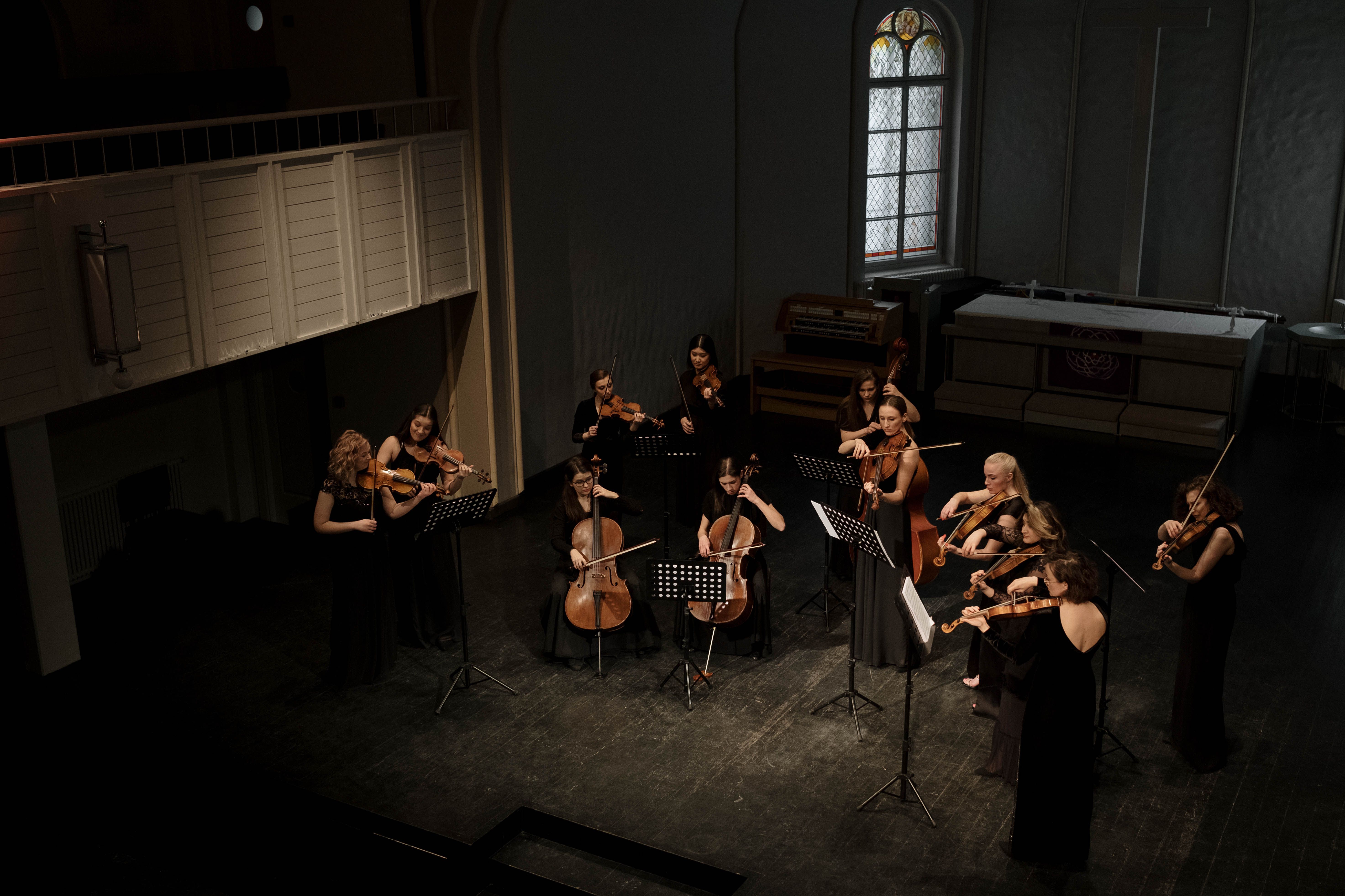 A Group of People Playing Musical Instruments on Stage · Free Stock Photo