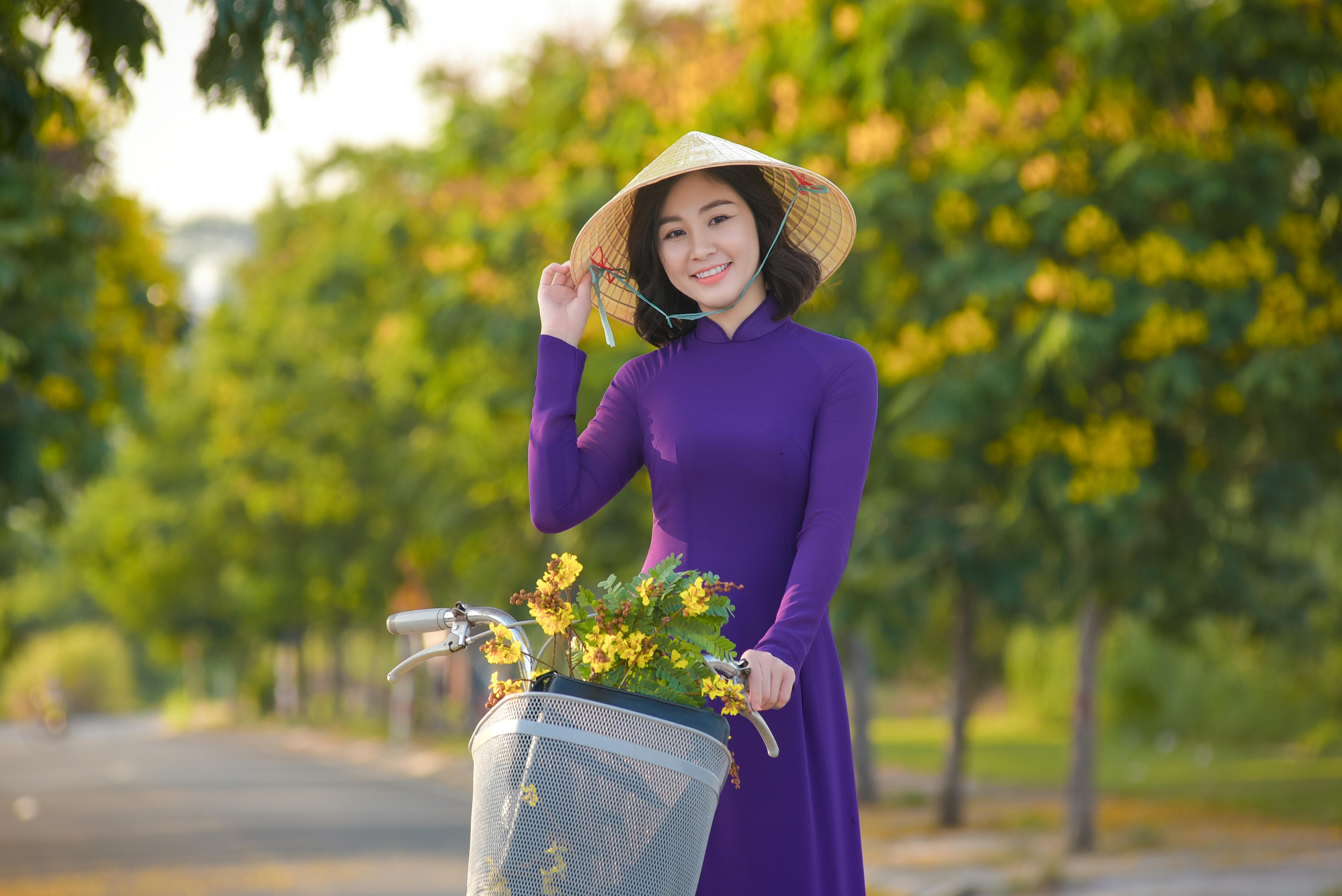 A Woman in Purple Dress Riding a Bike · Free Stock Photo